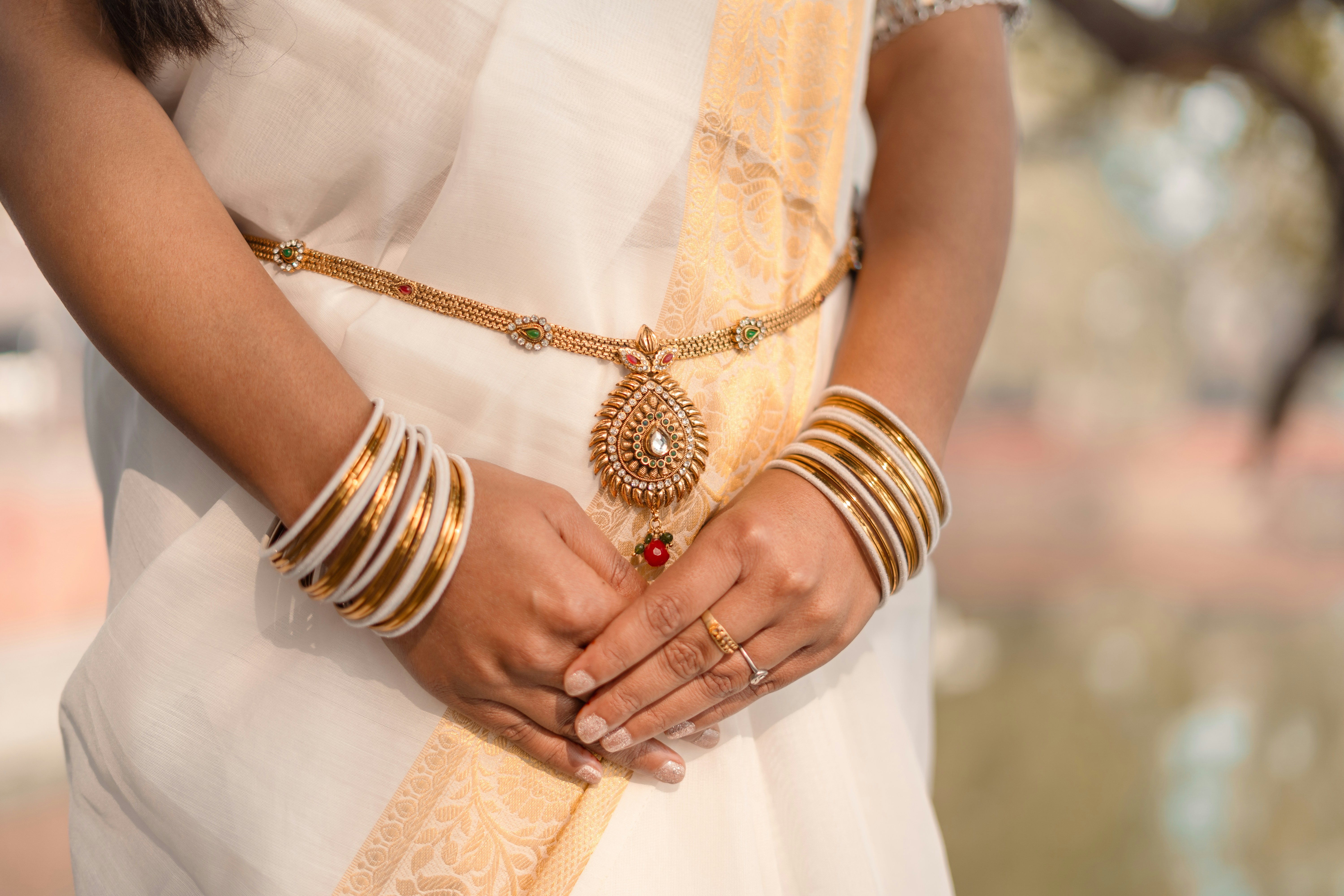 Hands in Heritage: Intricate Jewelry Framing a Sari-kissed Moment
