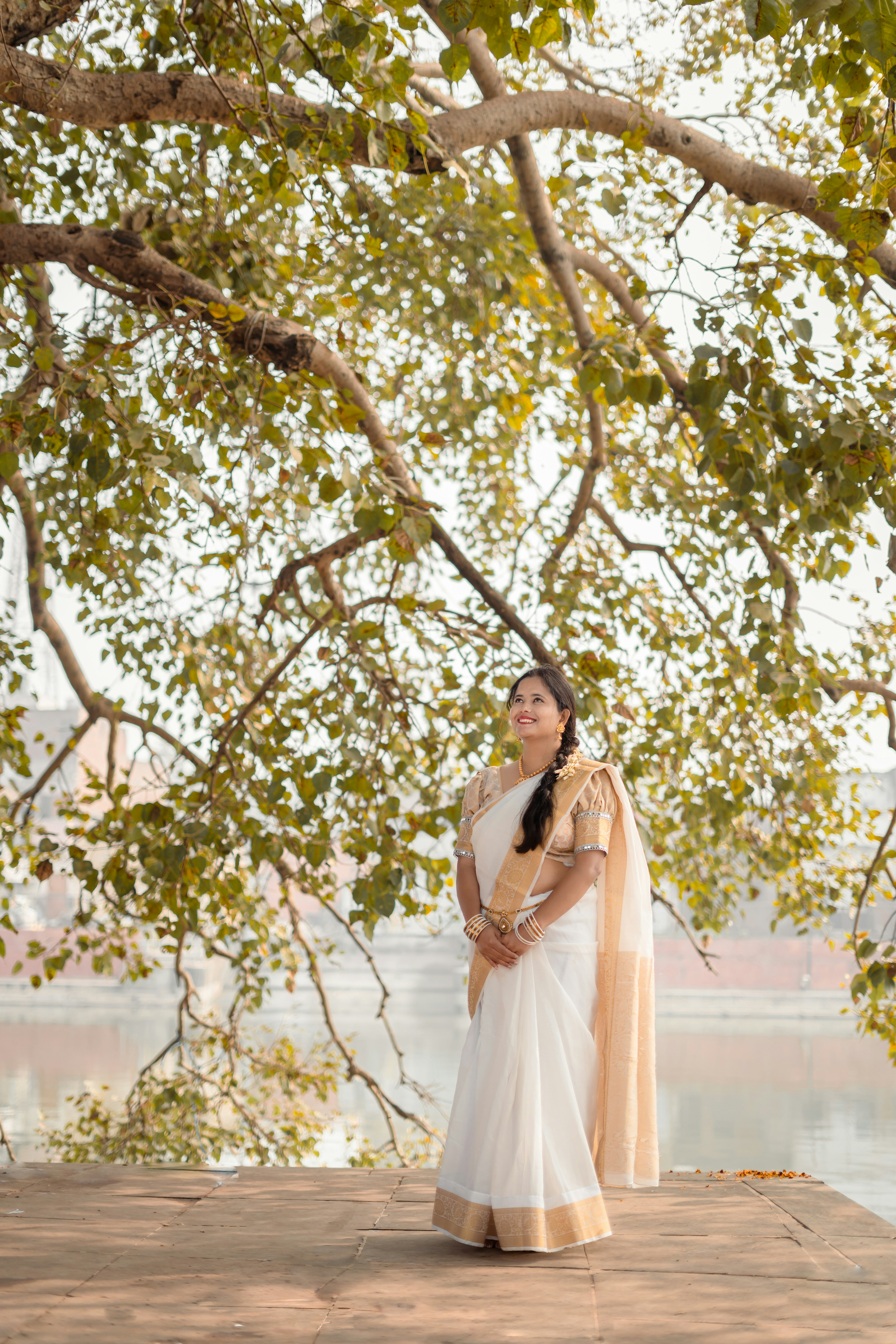 Grace Under the Branches: A Saree-Clad Moment by the Water