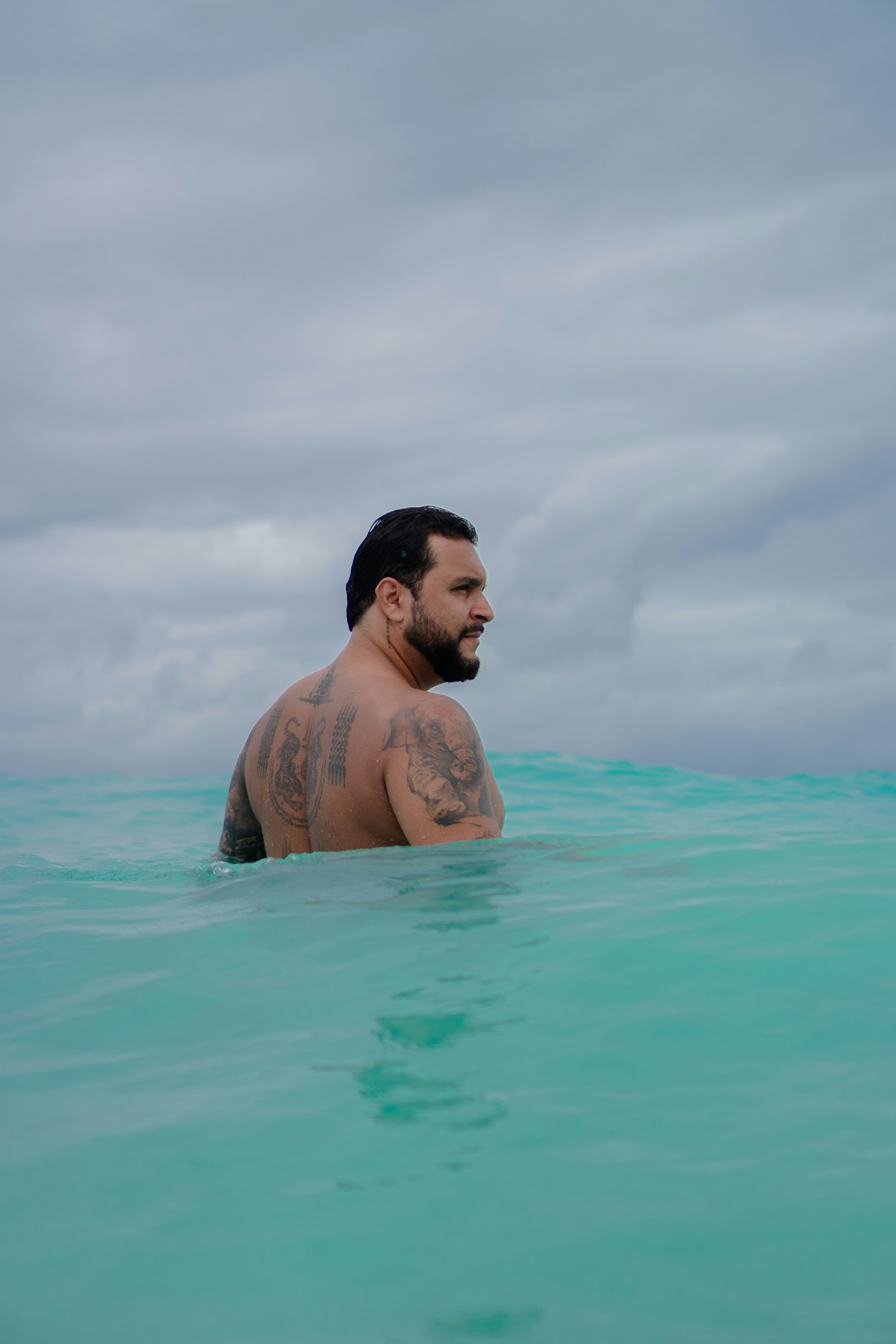 Surfer with Tattooed Back Rails the Turquoise Horizon