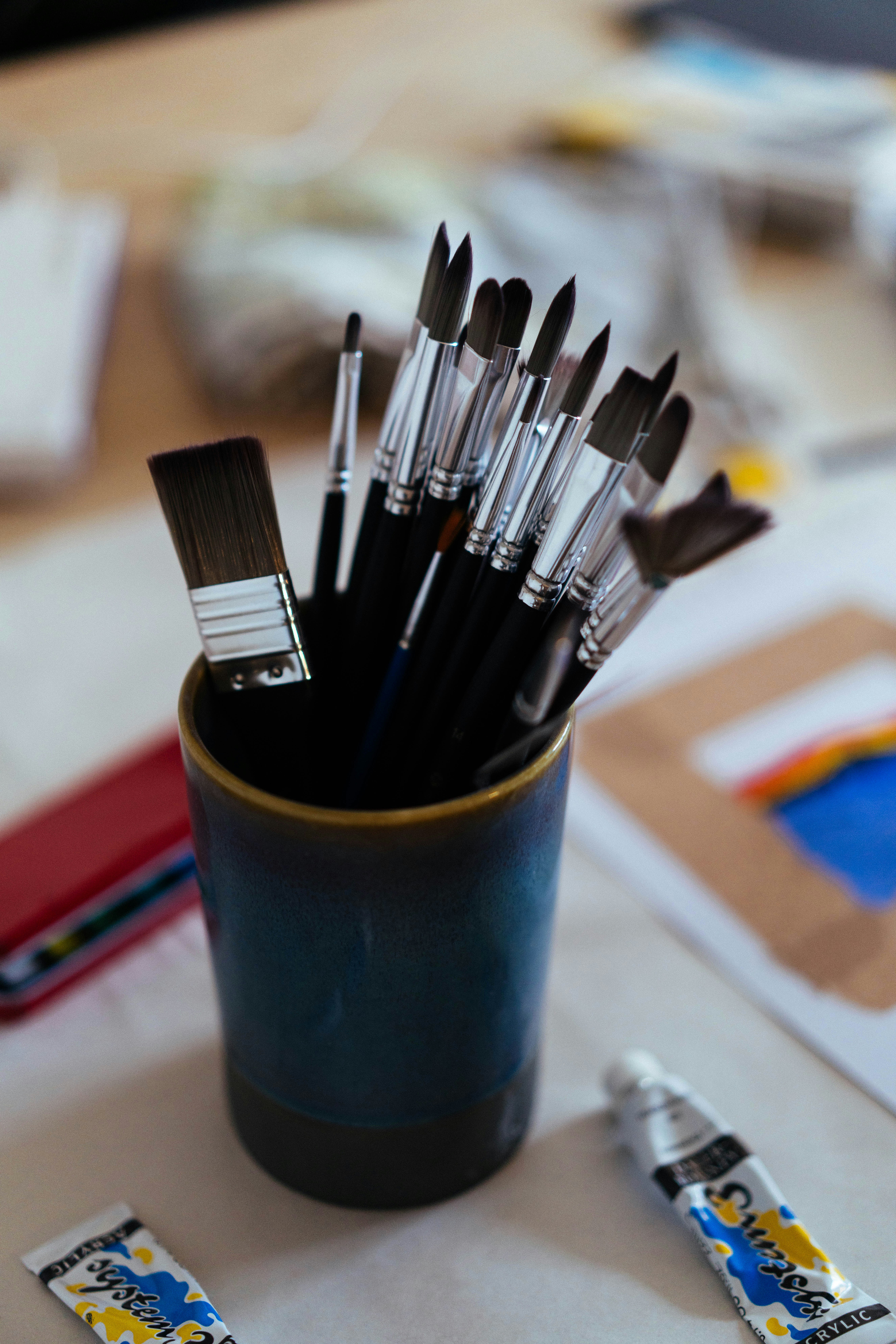 Studio Palette: A Cluster of Precision Brushes in a Deep Blue Cup