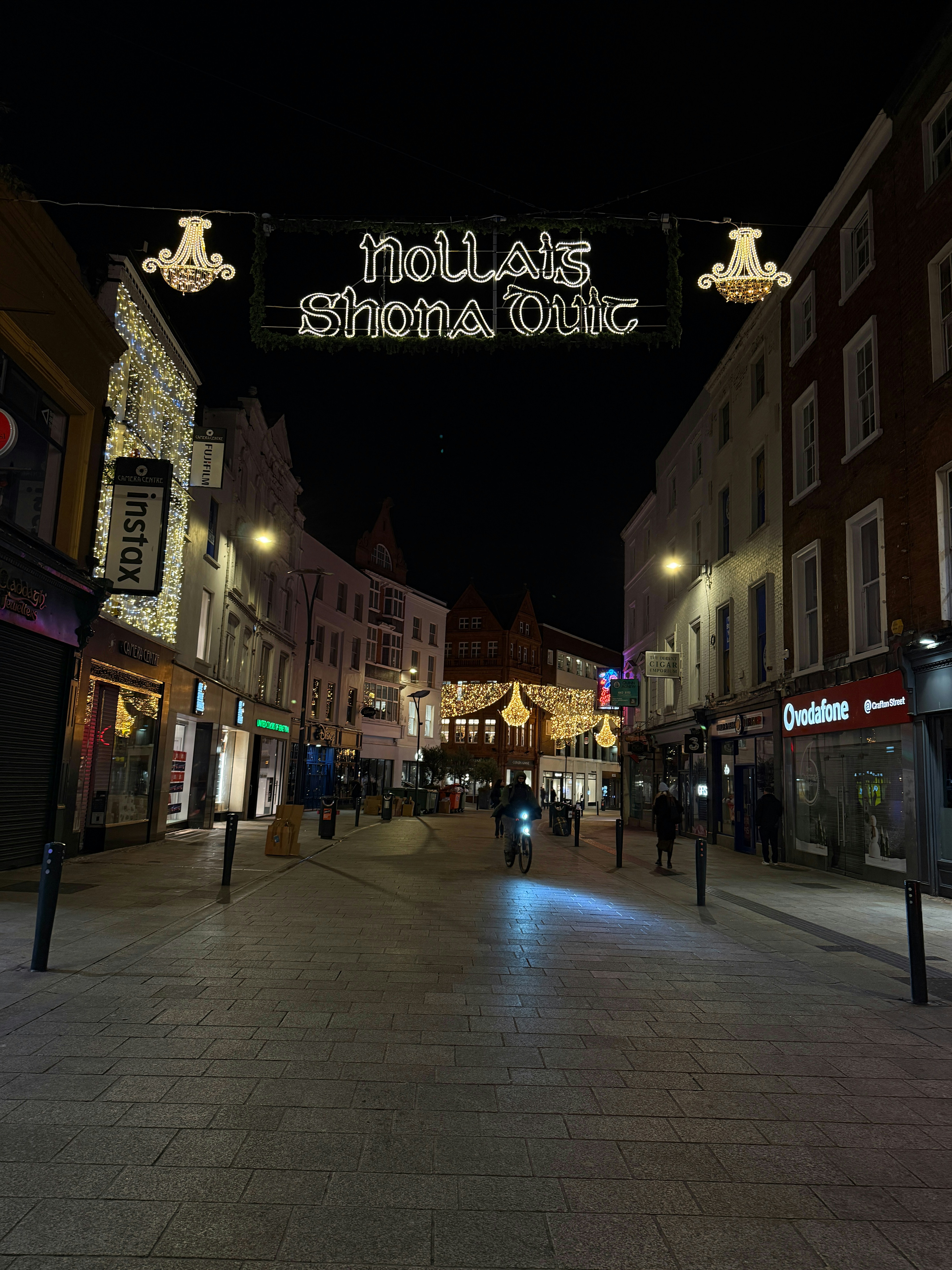 Night Street in Festive Glow Under Decorative Arch