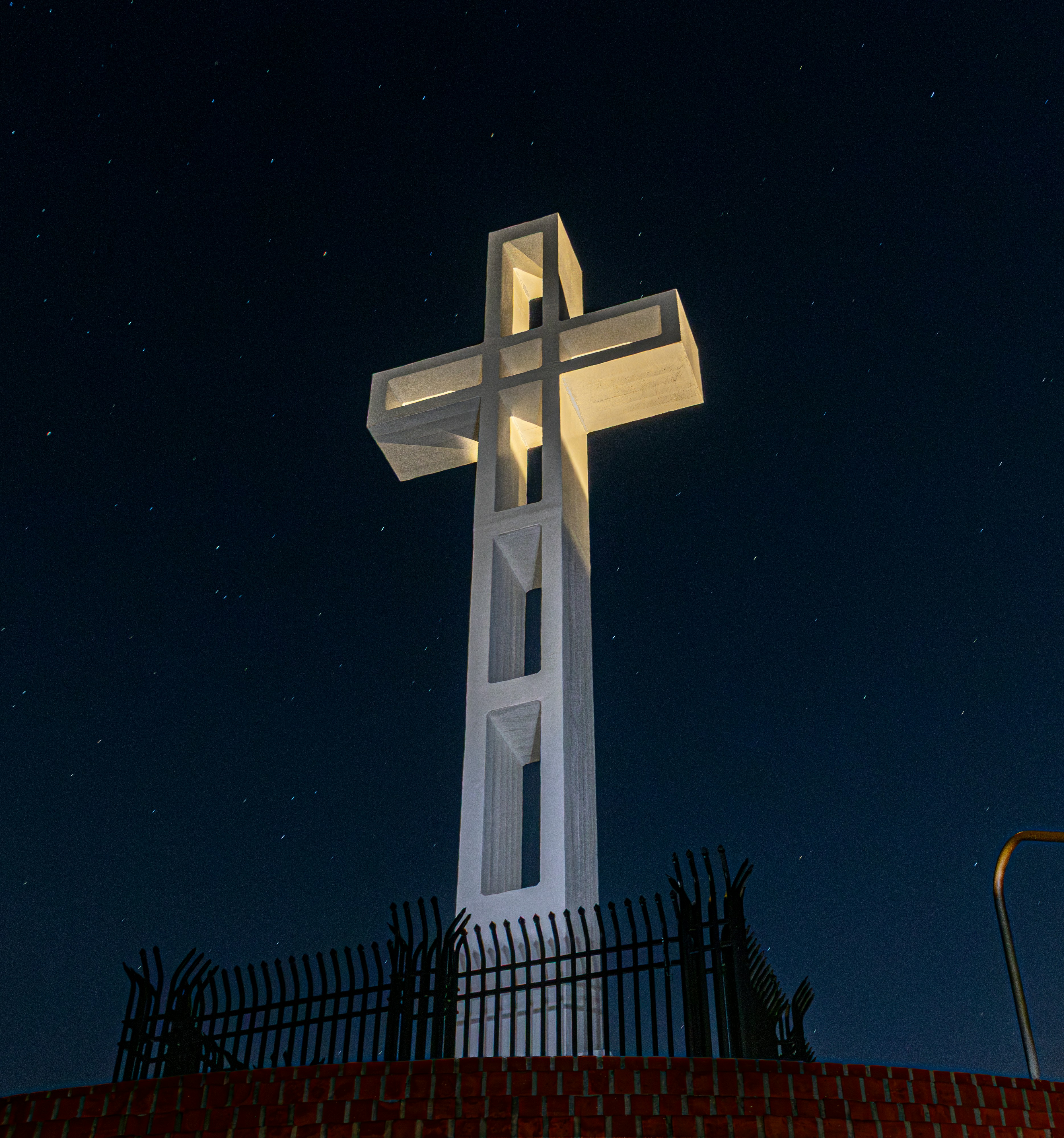 Evening Sentinel: A Illuminated Cross Against a Starry Sky