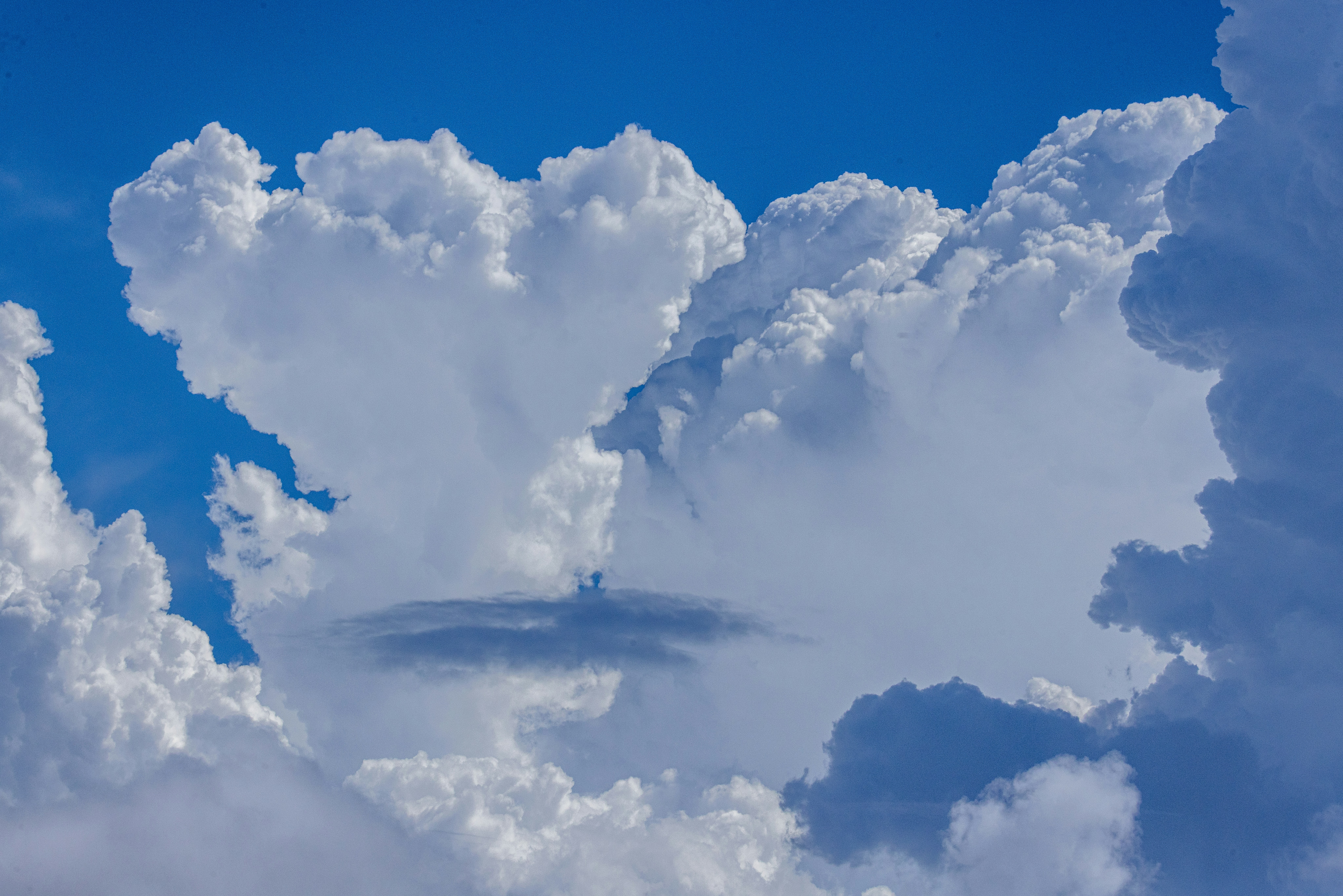 Cloud Cathedral: A Veil of White Peaks Against a Blue Sky