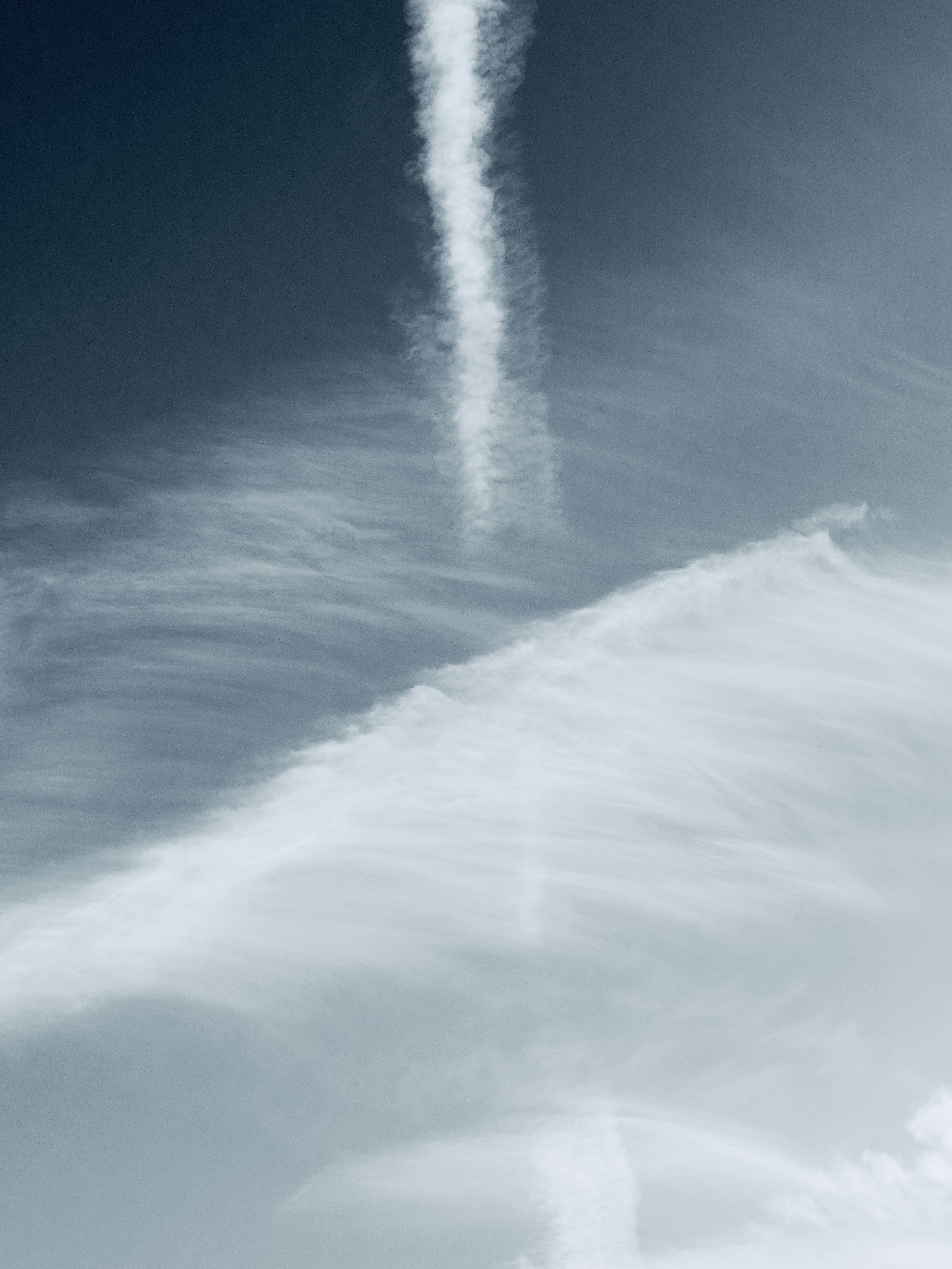 Jet of Vapor: A Skyward Line Cutting Through Turquoise Light