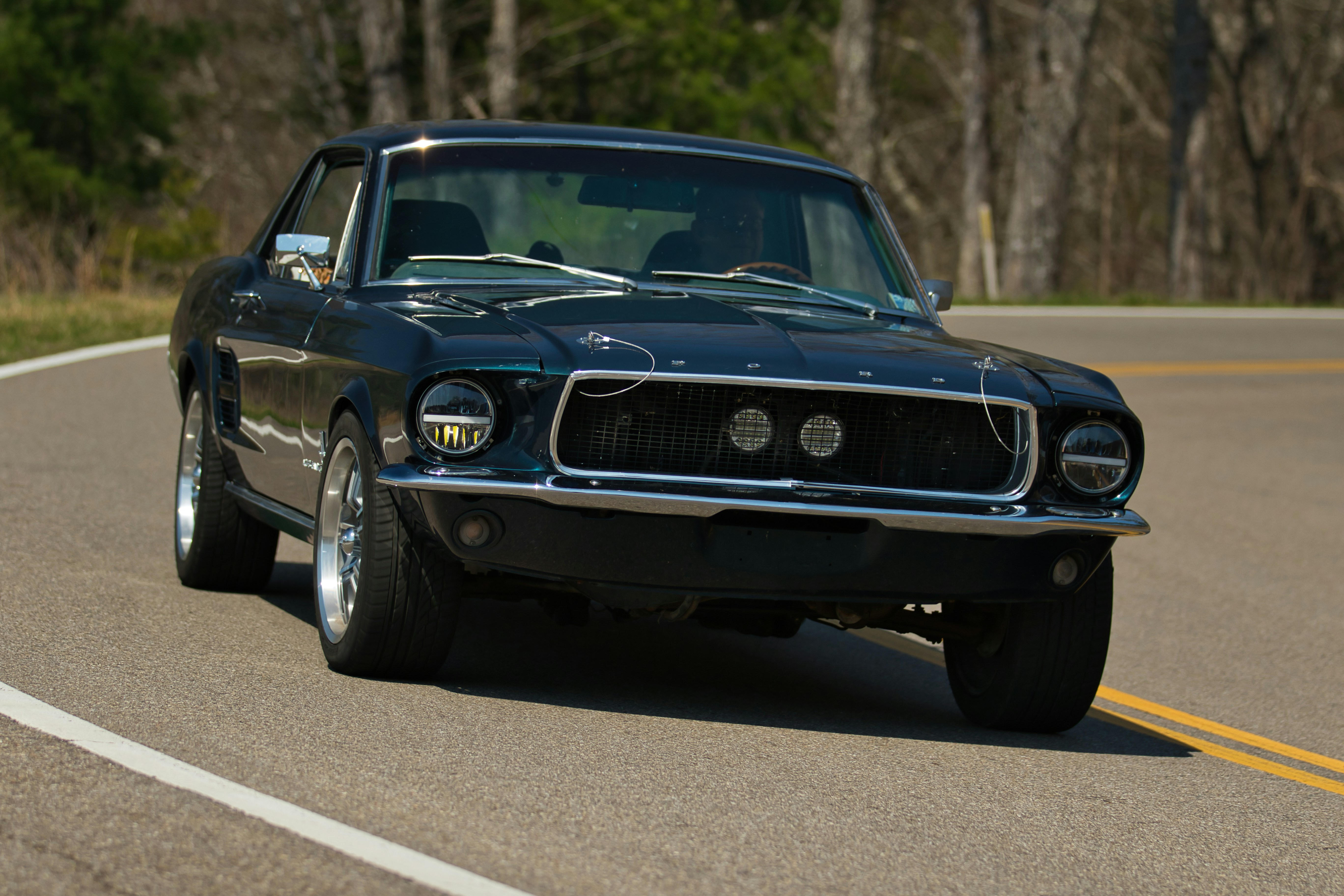 Blue Classic Mustang Drifting through a Quiet Curve