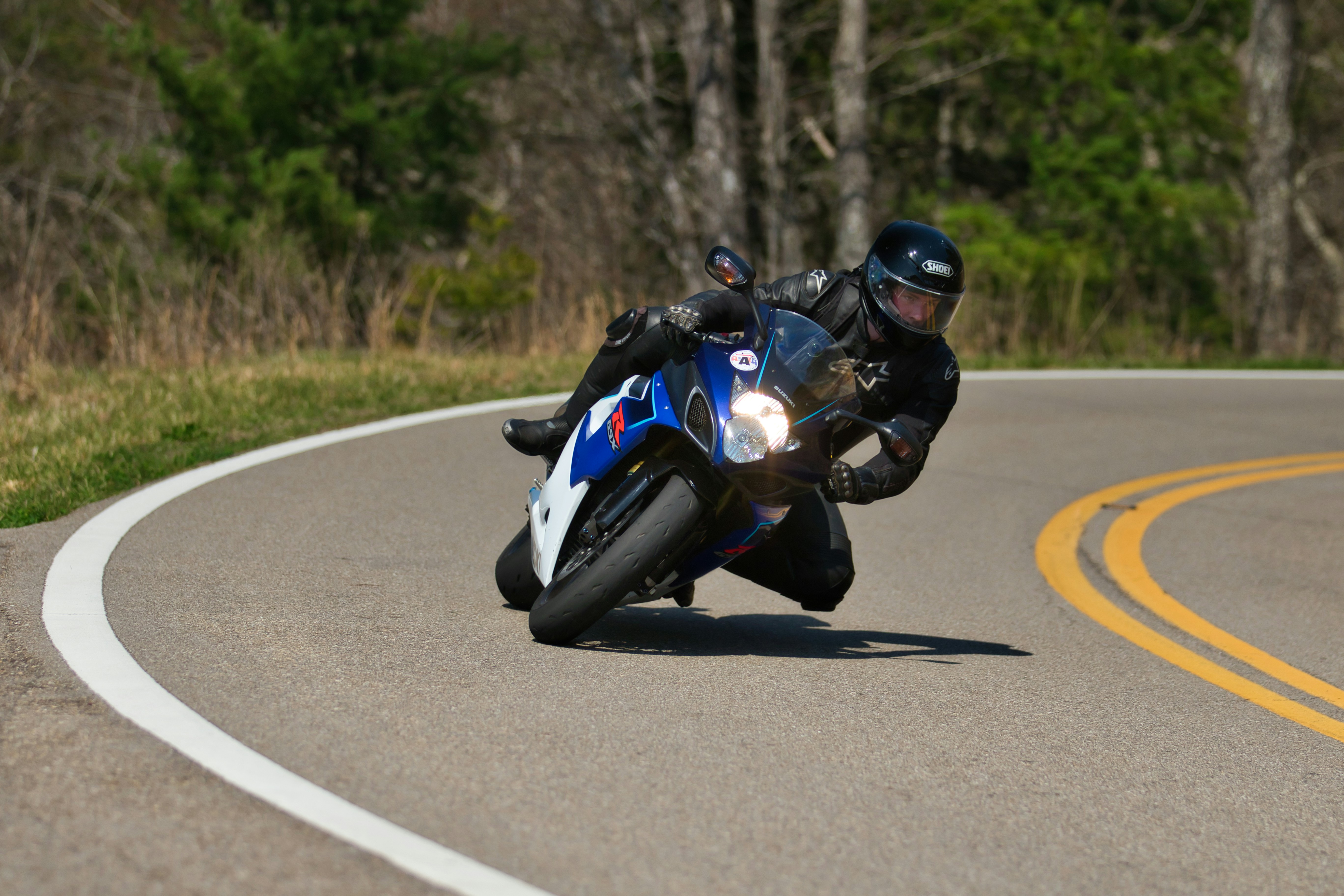 Rider’s Crimson Blur: A Sharp Turn on a Quiet Highway