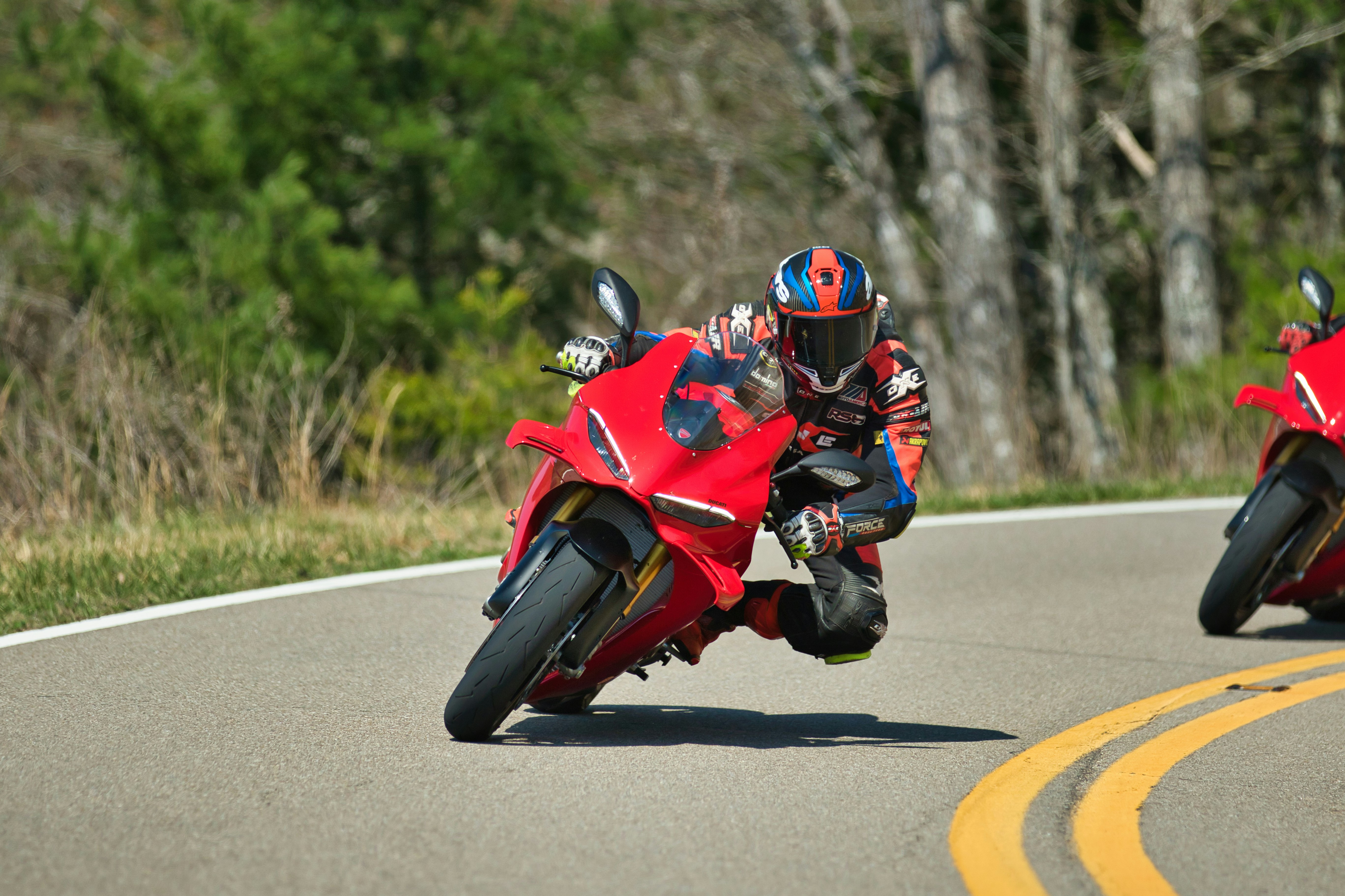Lean into the Curve: Red Moto Duo Takes a Sharp Turn