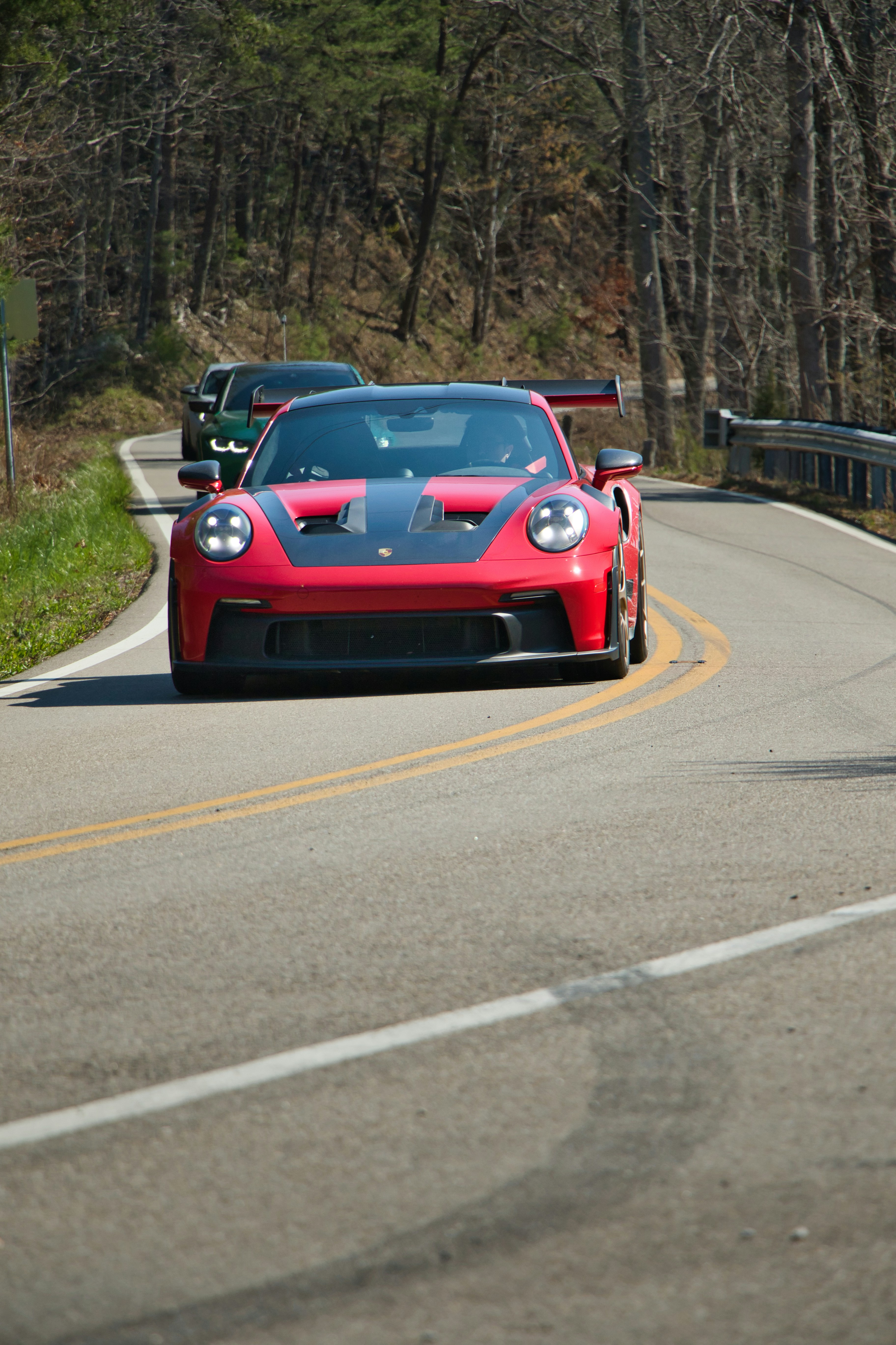 Red Apex: The Lead Car Rounding a Winding Country Road