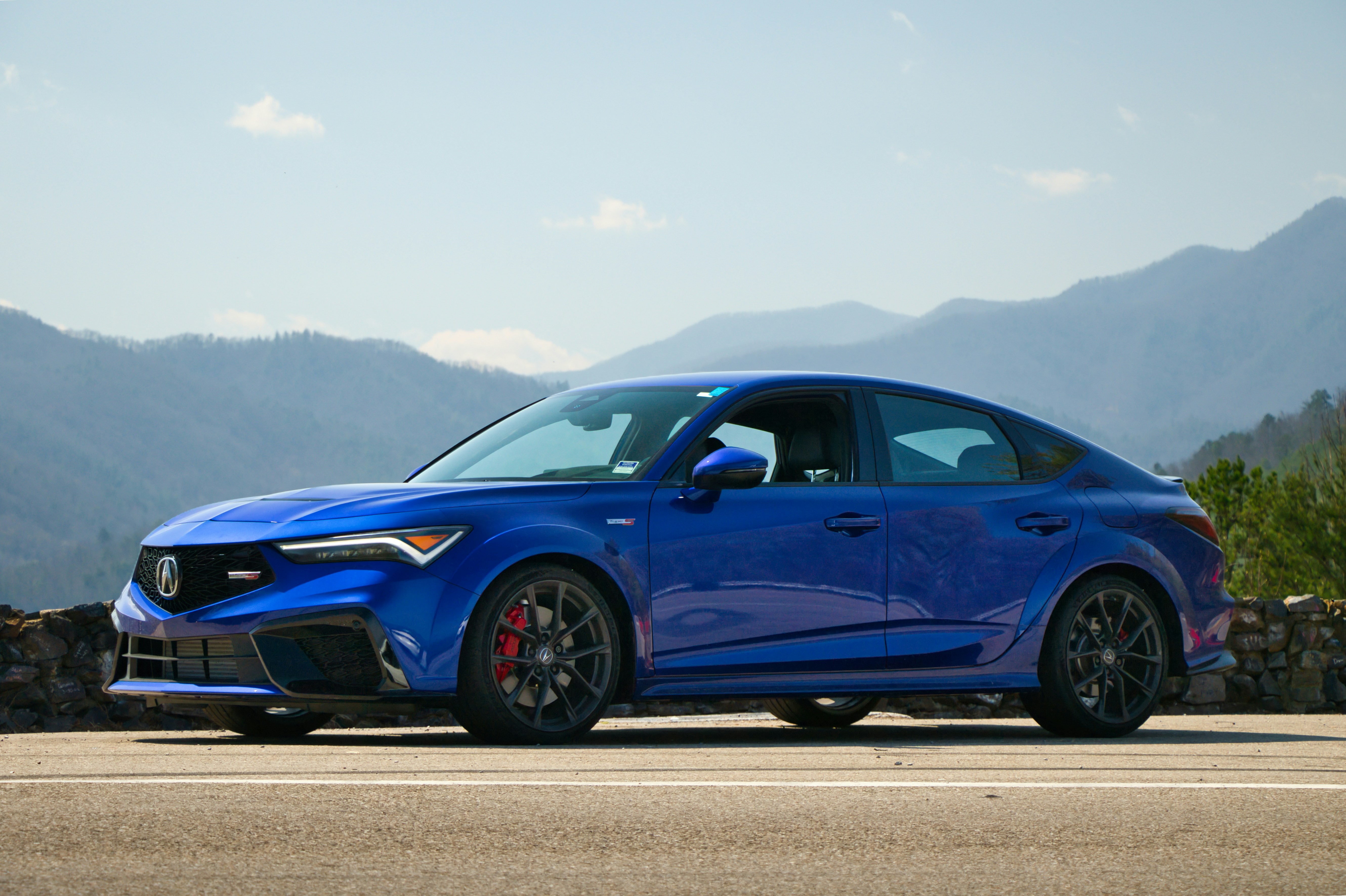 Blue Agility: A Blue RS sedan poised on an open highway
