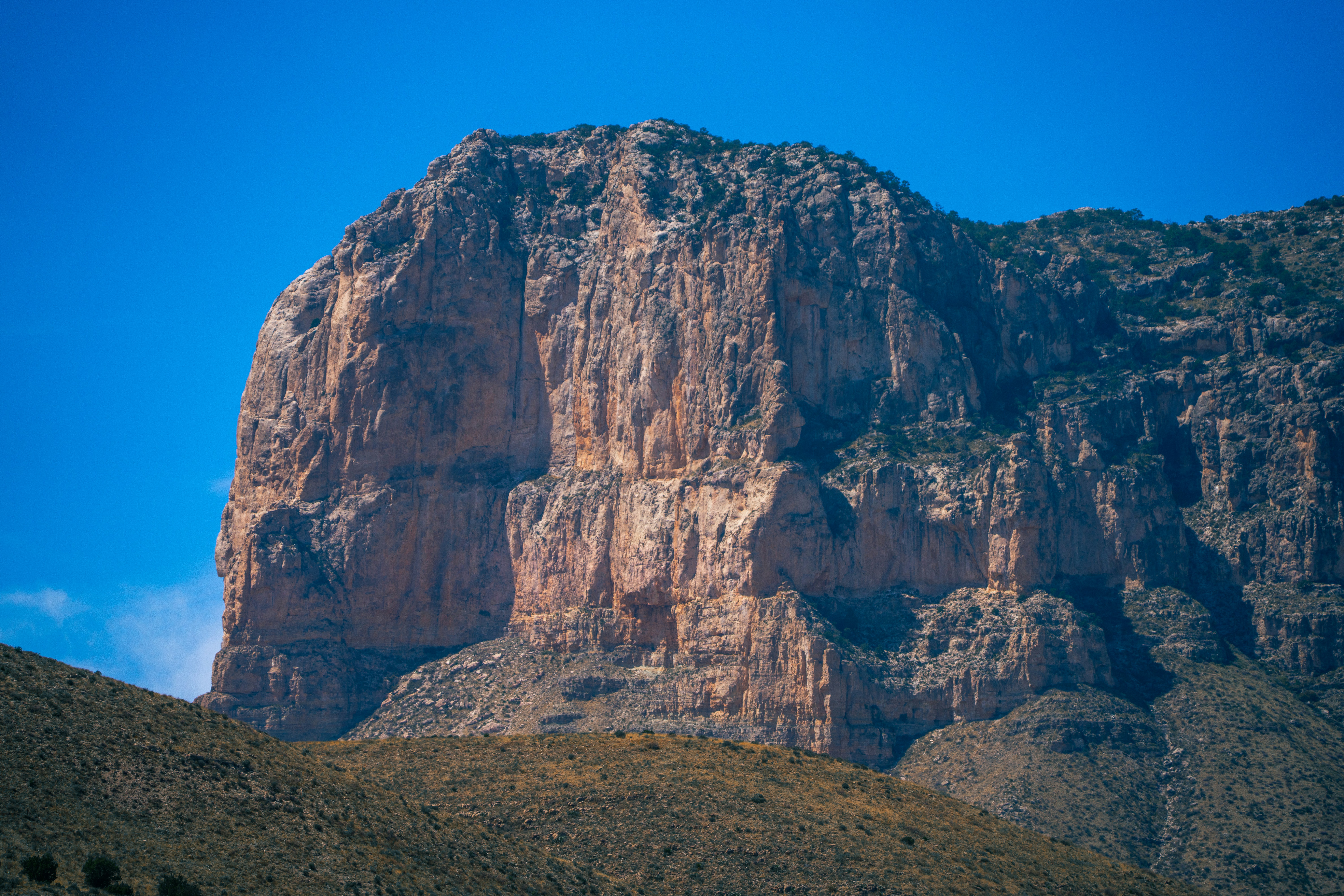 Monolithic Cliff: Sunlit Mesa Rising from Desert Valleys