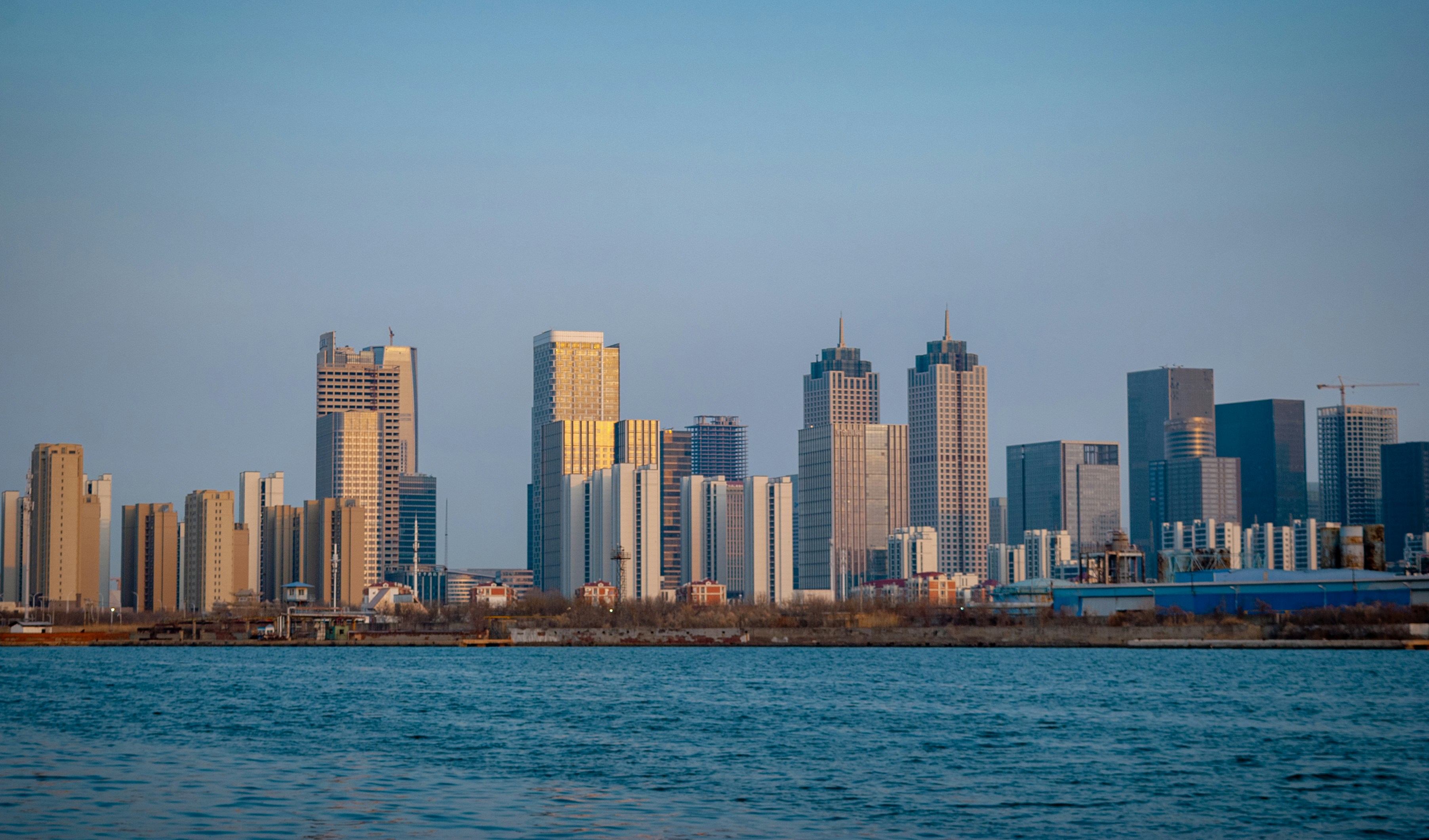 Harbor Silhouette: City Skyline Basking in Evening Light