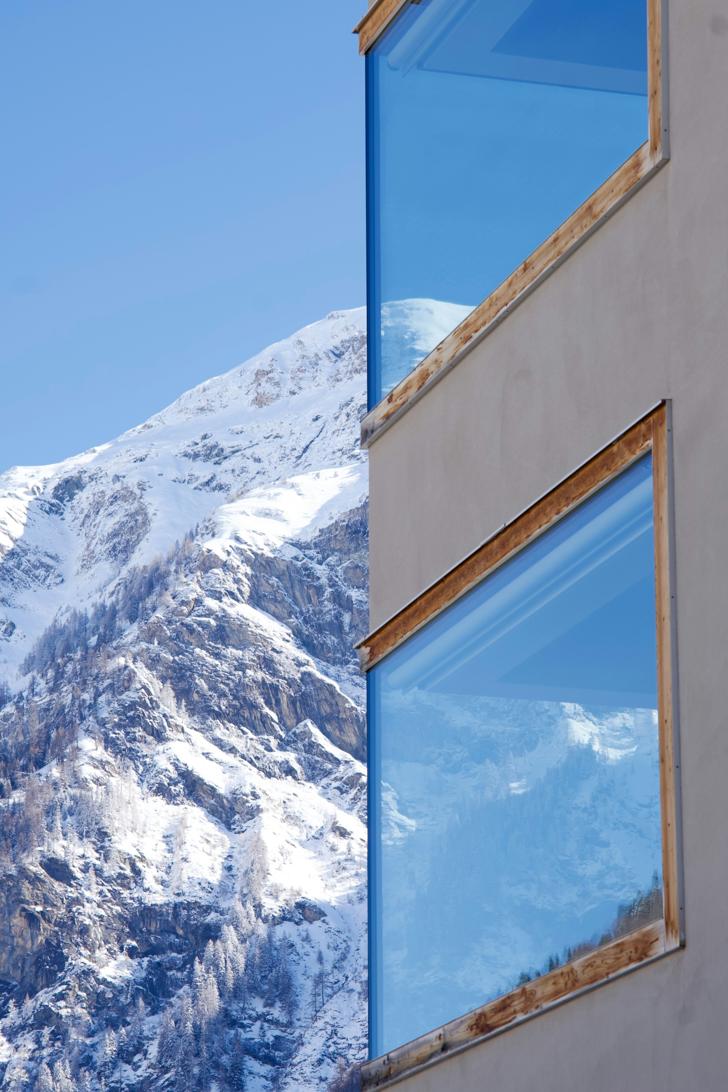 Snowy Peaks Reflected in Modern Glass
