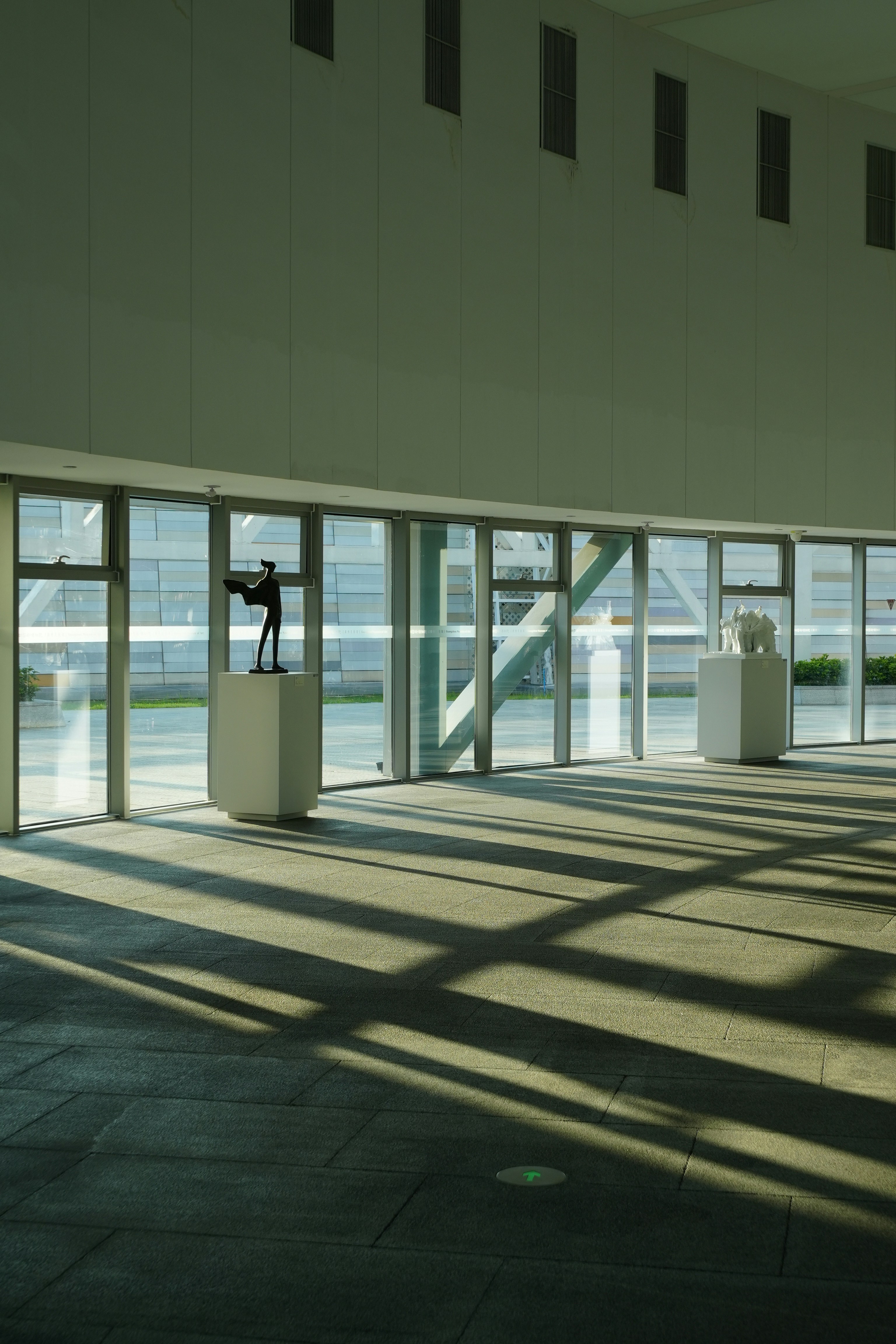 Echoes of Light: Minimalist Gallery Interior with Sculptures