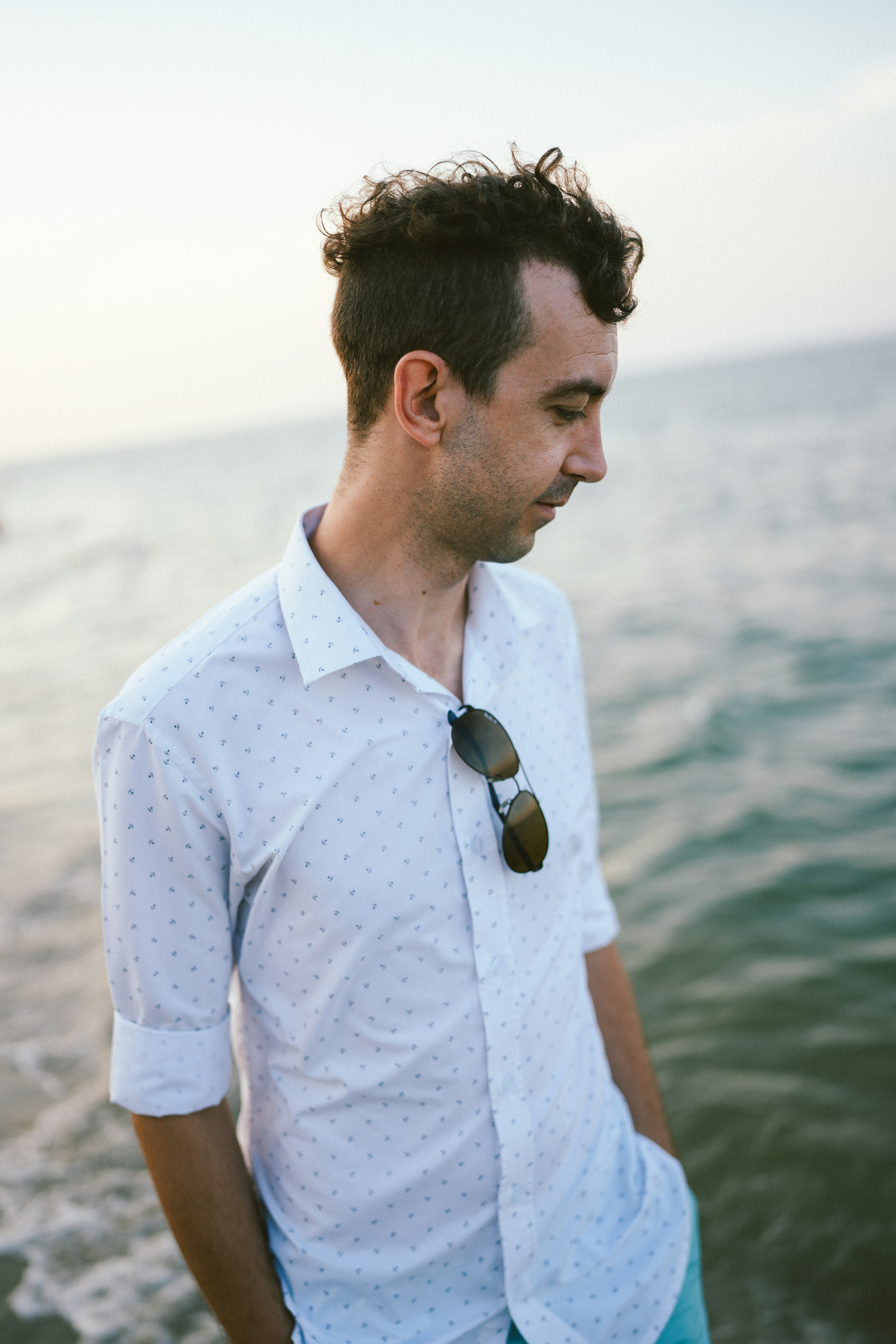 Coastal Portrait in Soft Light with Sunglasses Rested on Shirt
