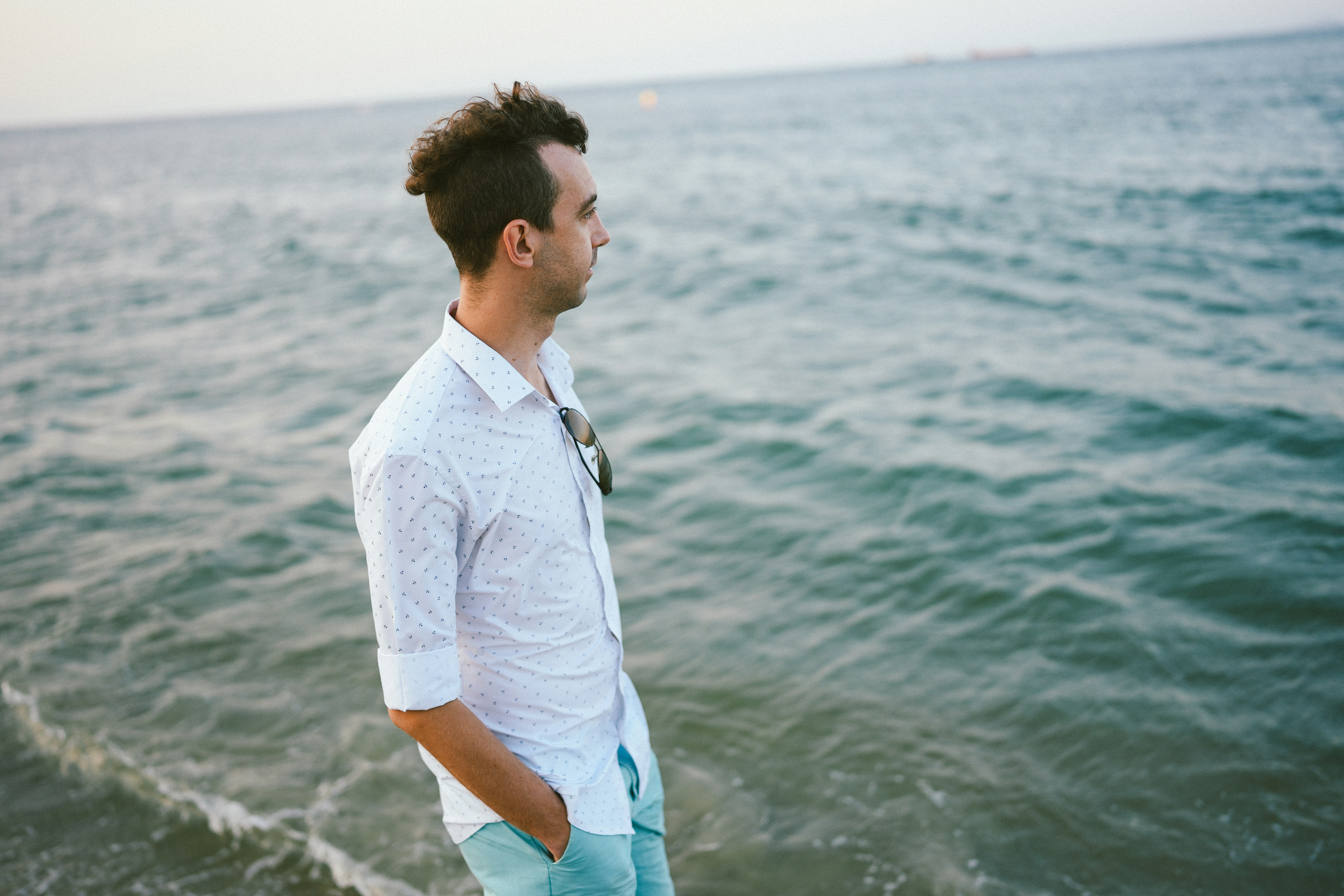 Coastal Portrait: A Man at the Edge of Calm Waters