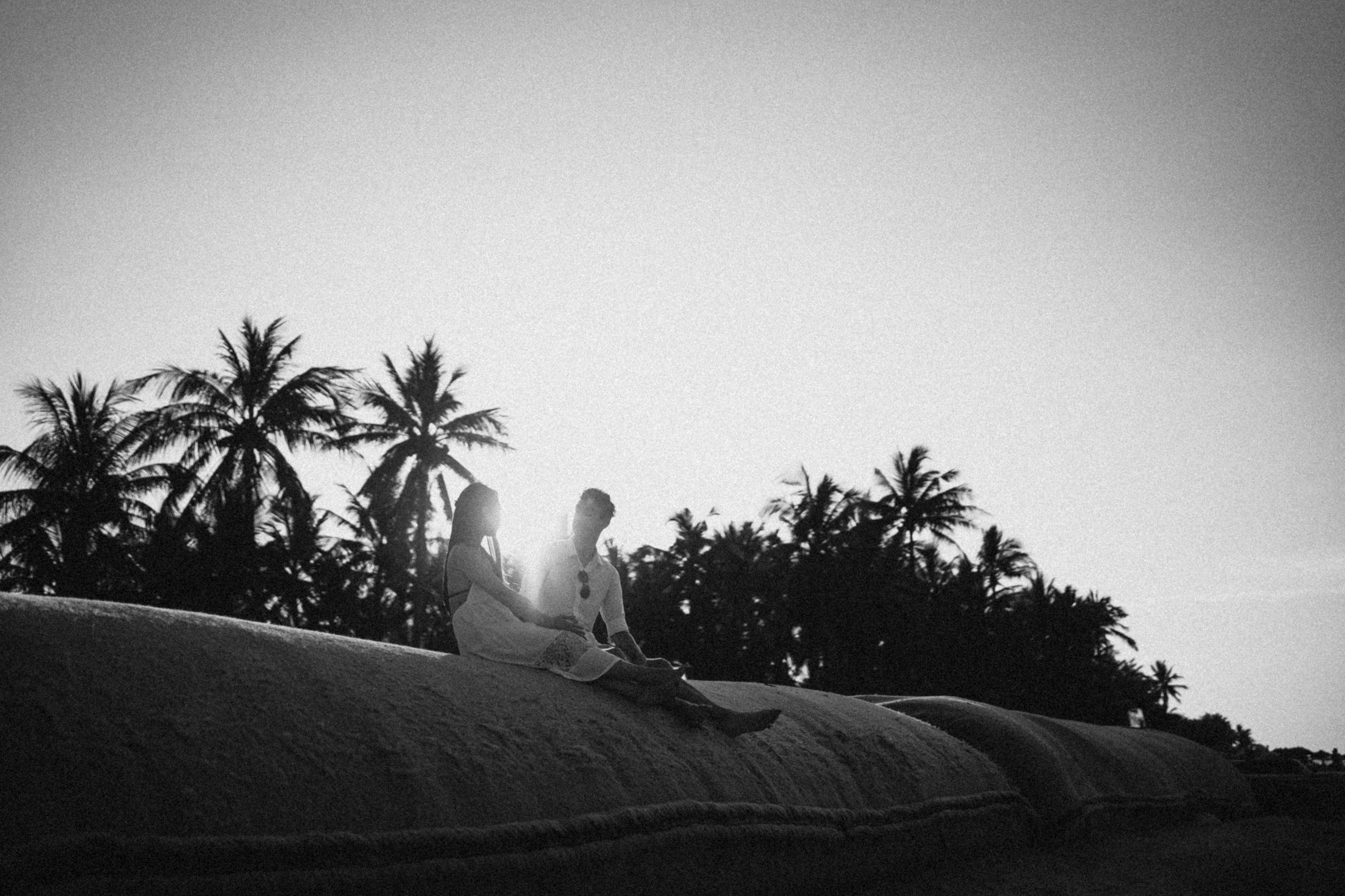 Sunlit silhouettes on a tropical seawall