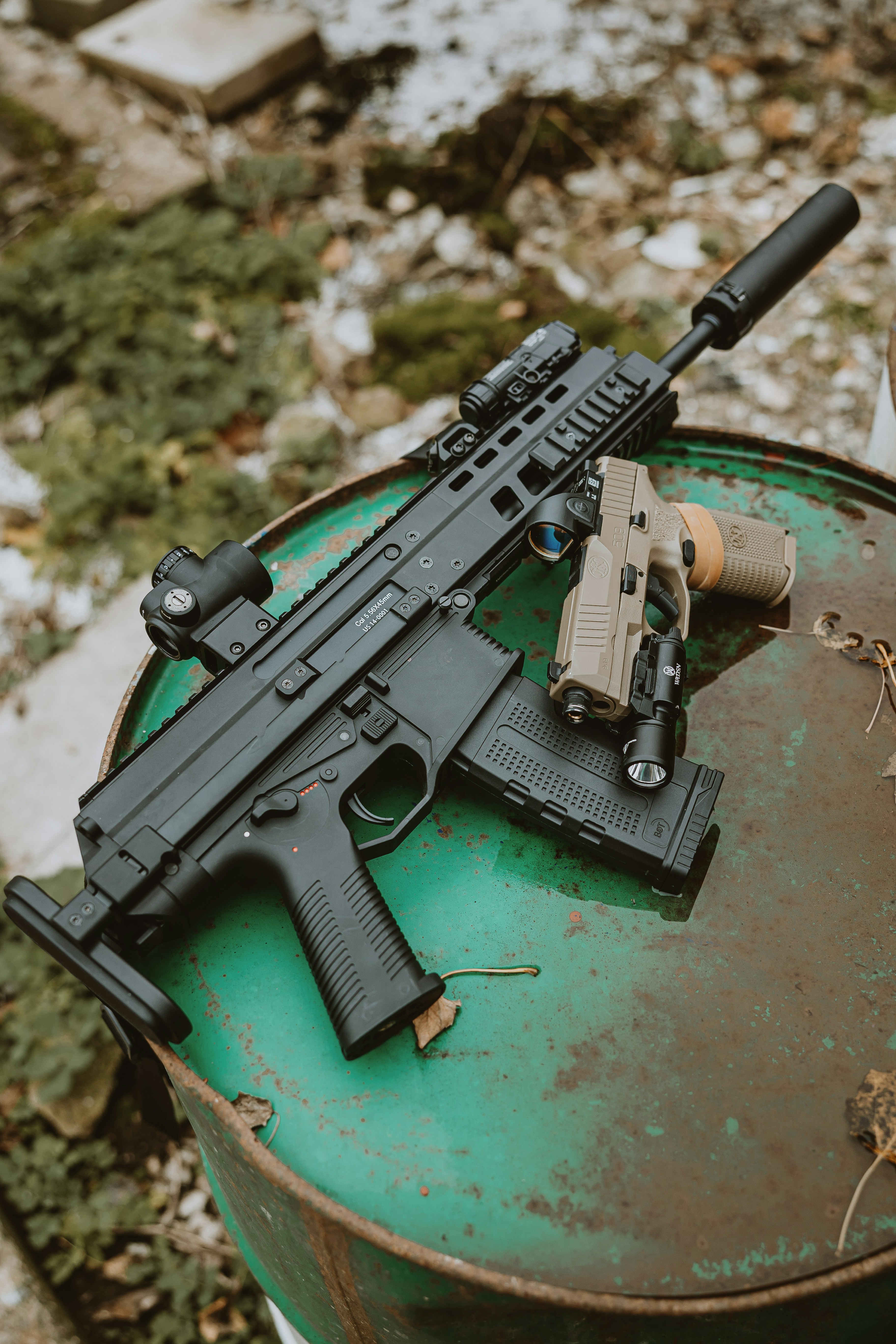 Beast of the Green Cylinder: Tactical Rifle Resting on Weathered Barrel