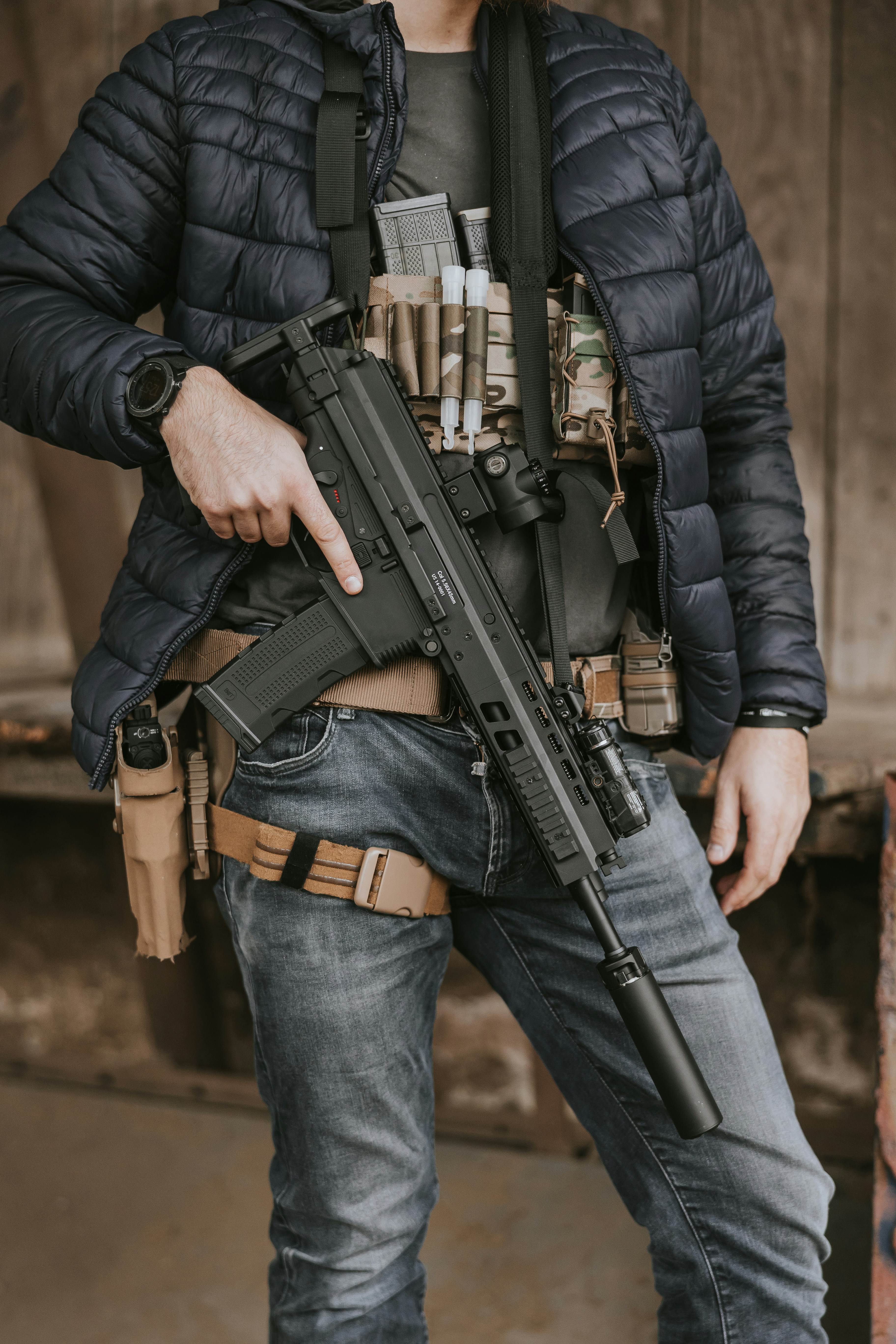 Close-up of a tactical operator with rifle and gear at hip level