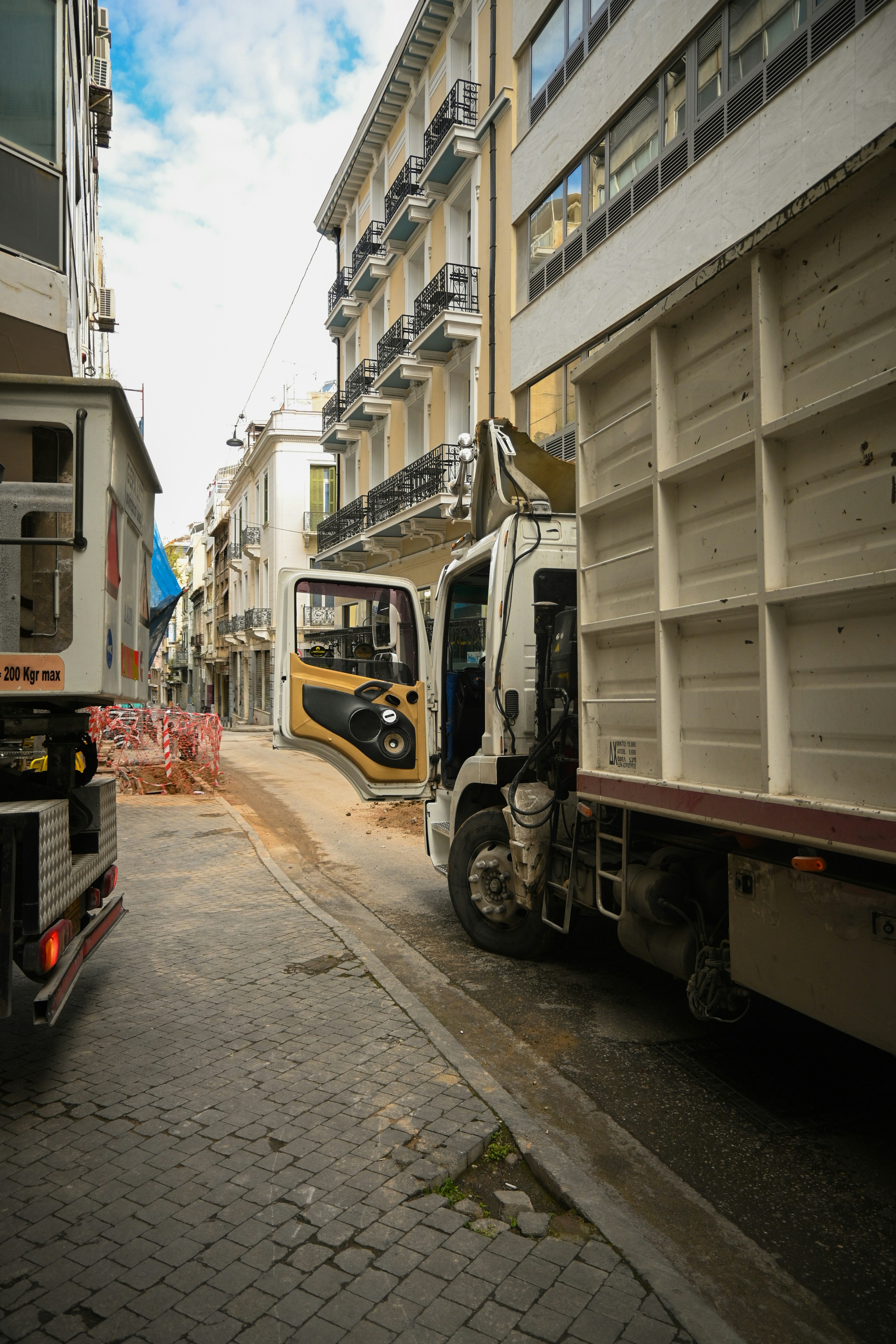 Delivery Alley: Open Doors and Open Road Between Tall City Blocks