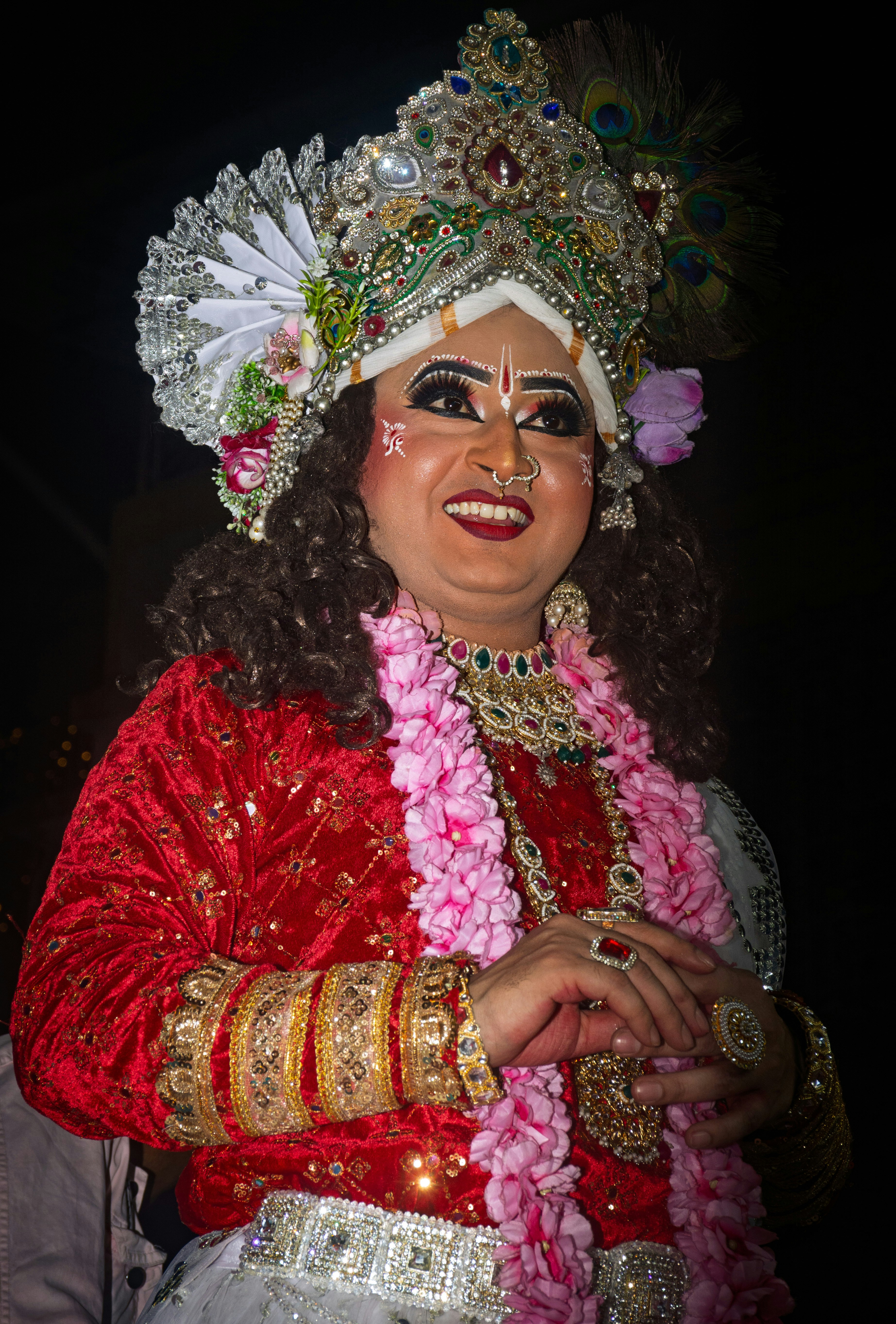 Regal Performer in Ornate Headdress and Floral Lei