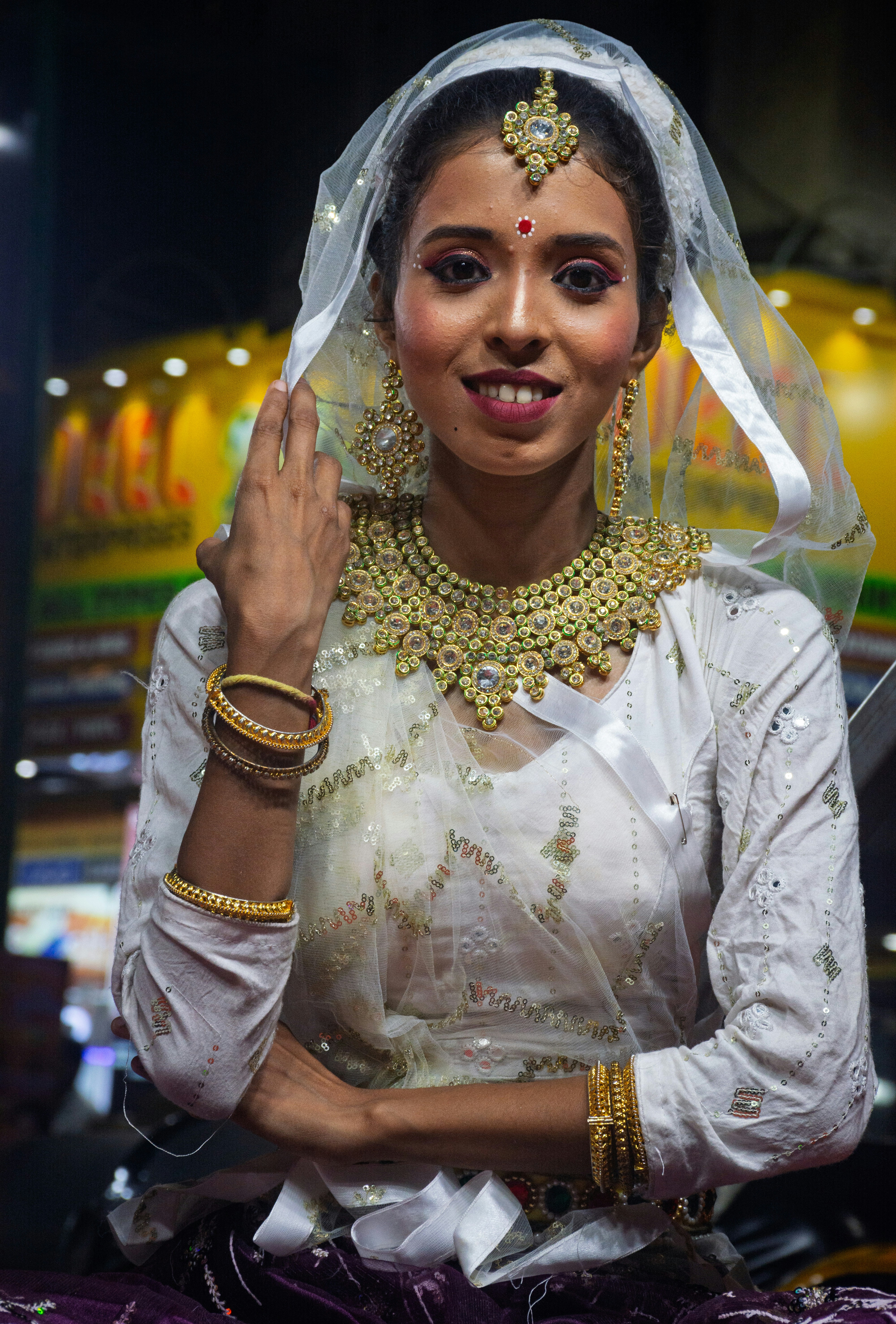 Regal bridal portrait: ornate jewelry and veil in a festive setting