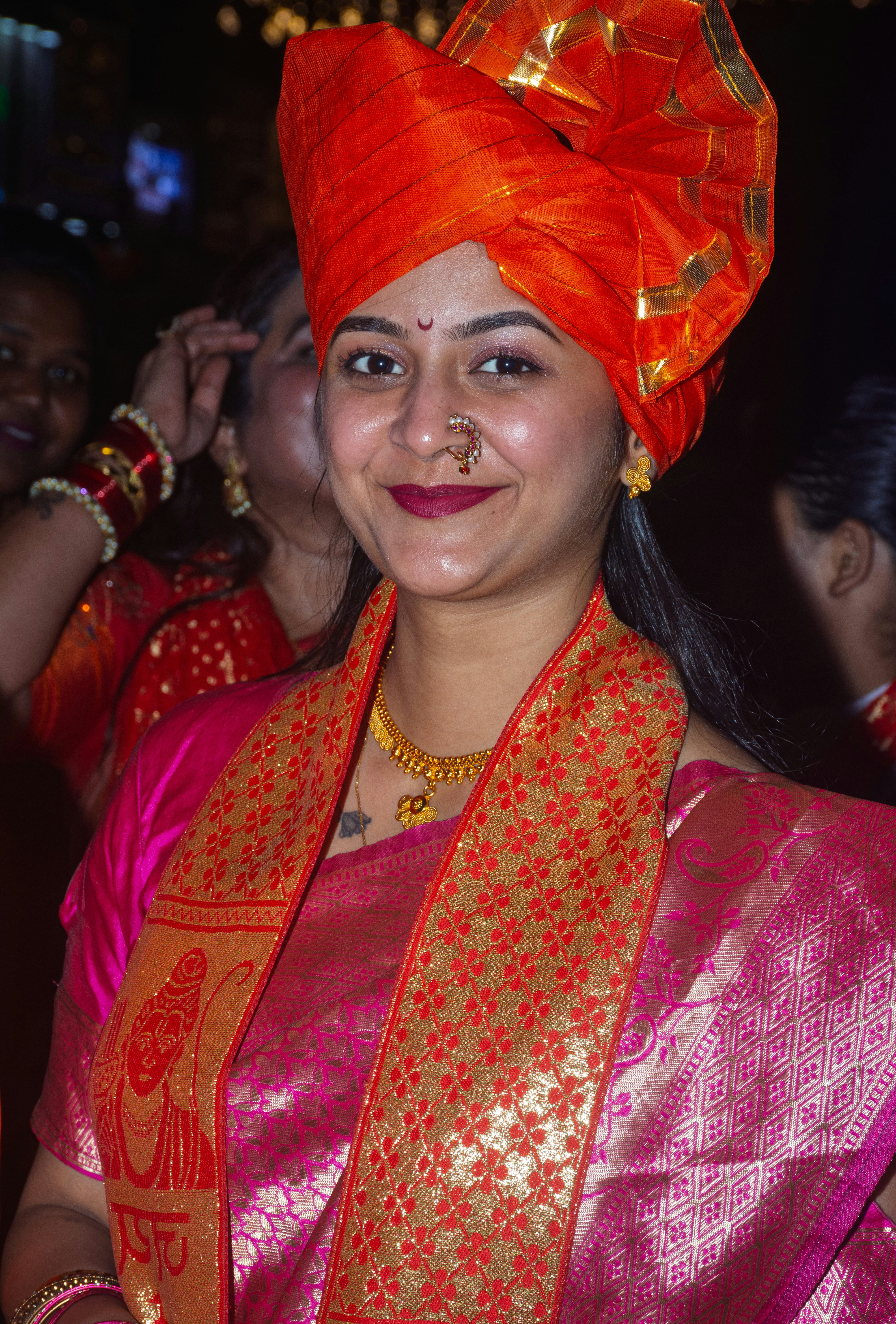 Radiant Turban and Jewel-Toned Attire at a Festive Moment