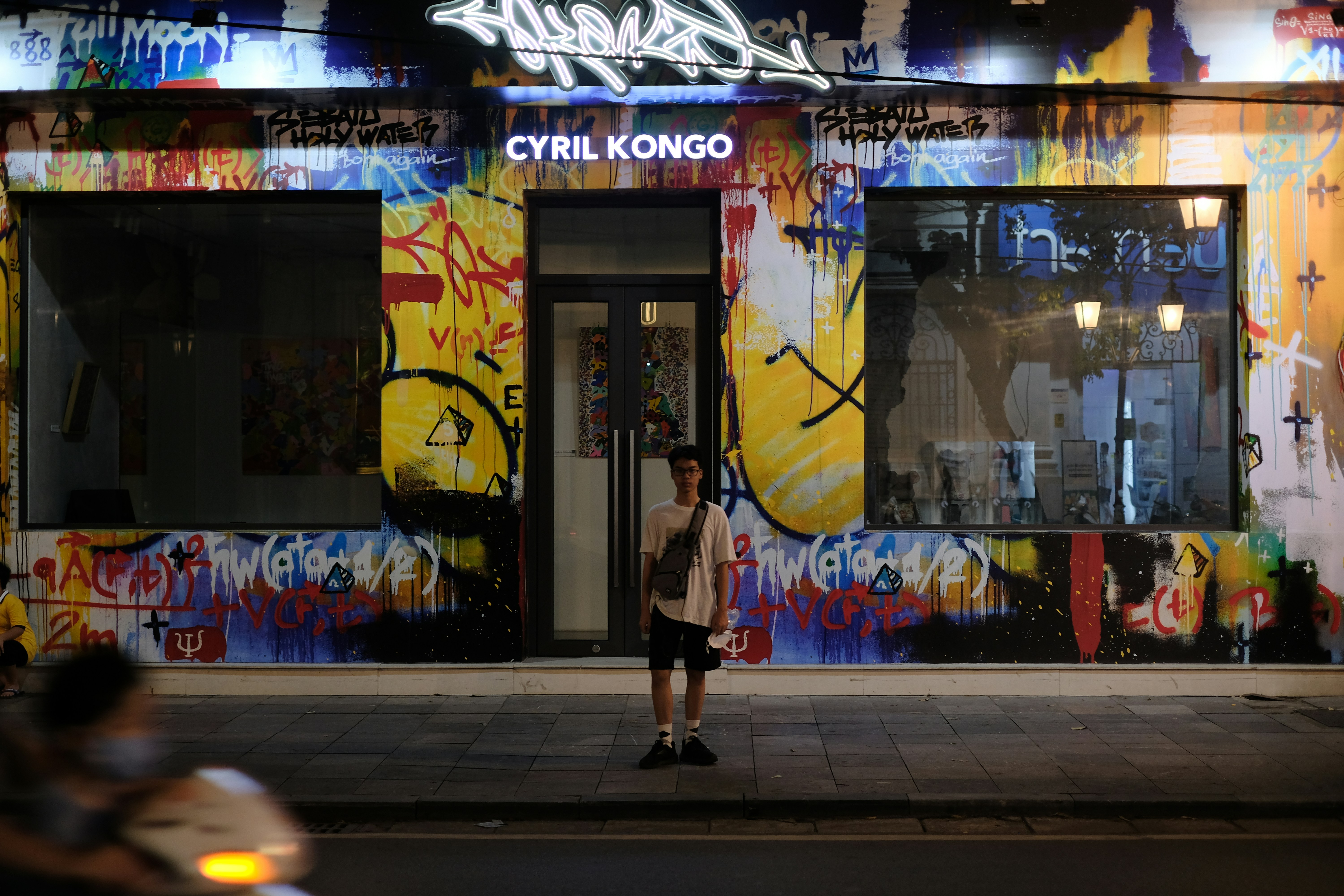 Center Stage under Neon Graffiti: A Solo Appears Before a Color-Wrapped Wall
