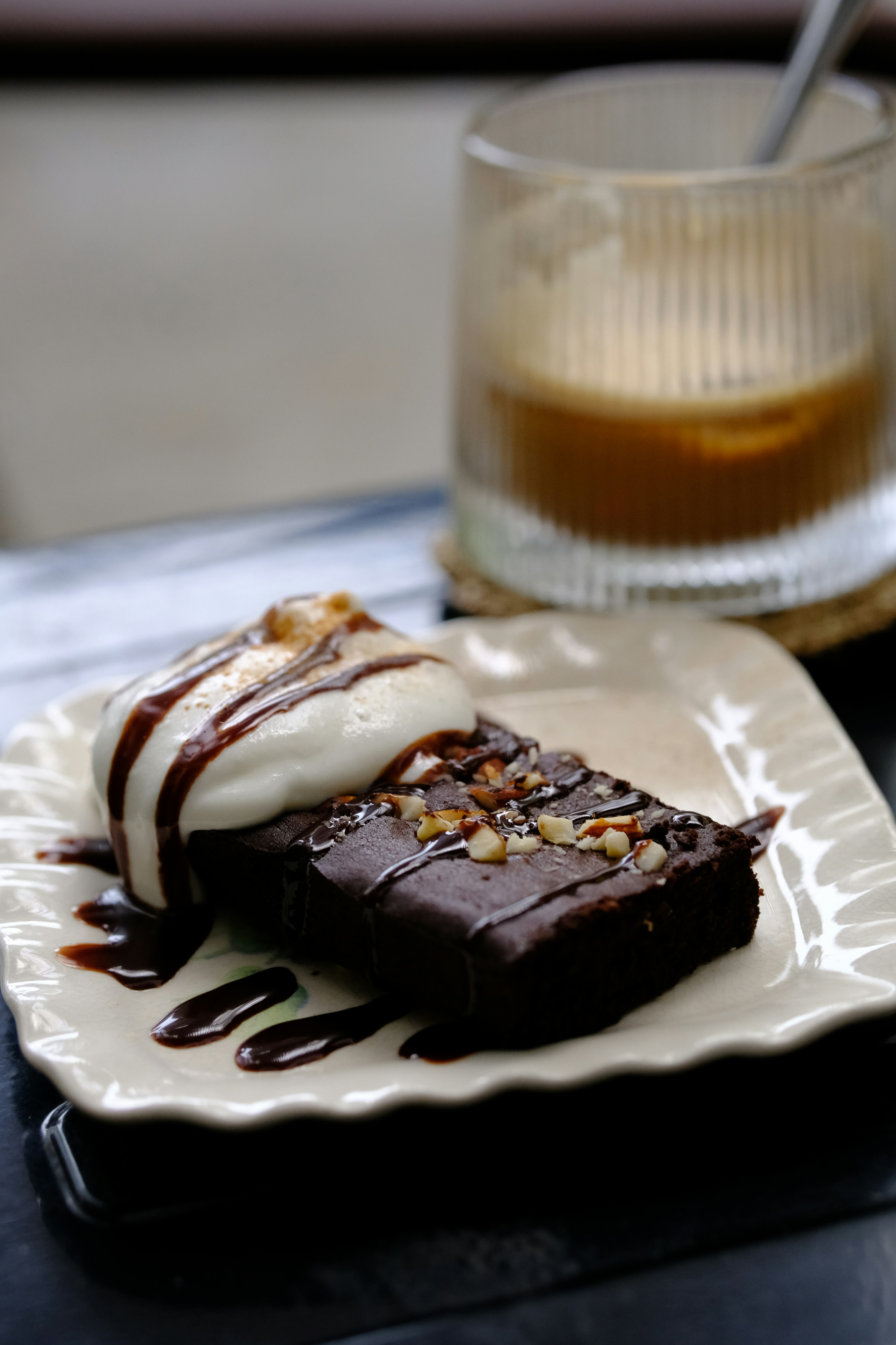Decadent Duo: Chocolate brownie and vanilla scoop with a glass of espresso
