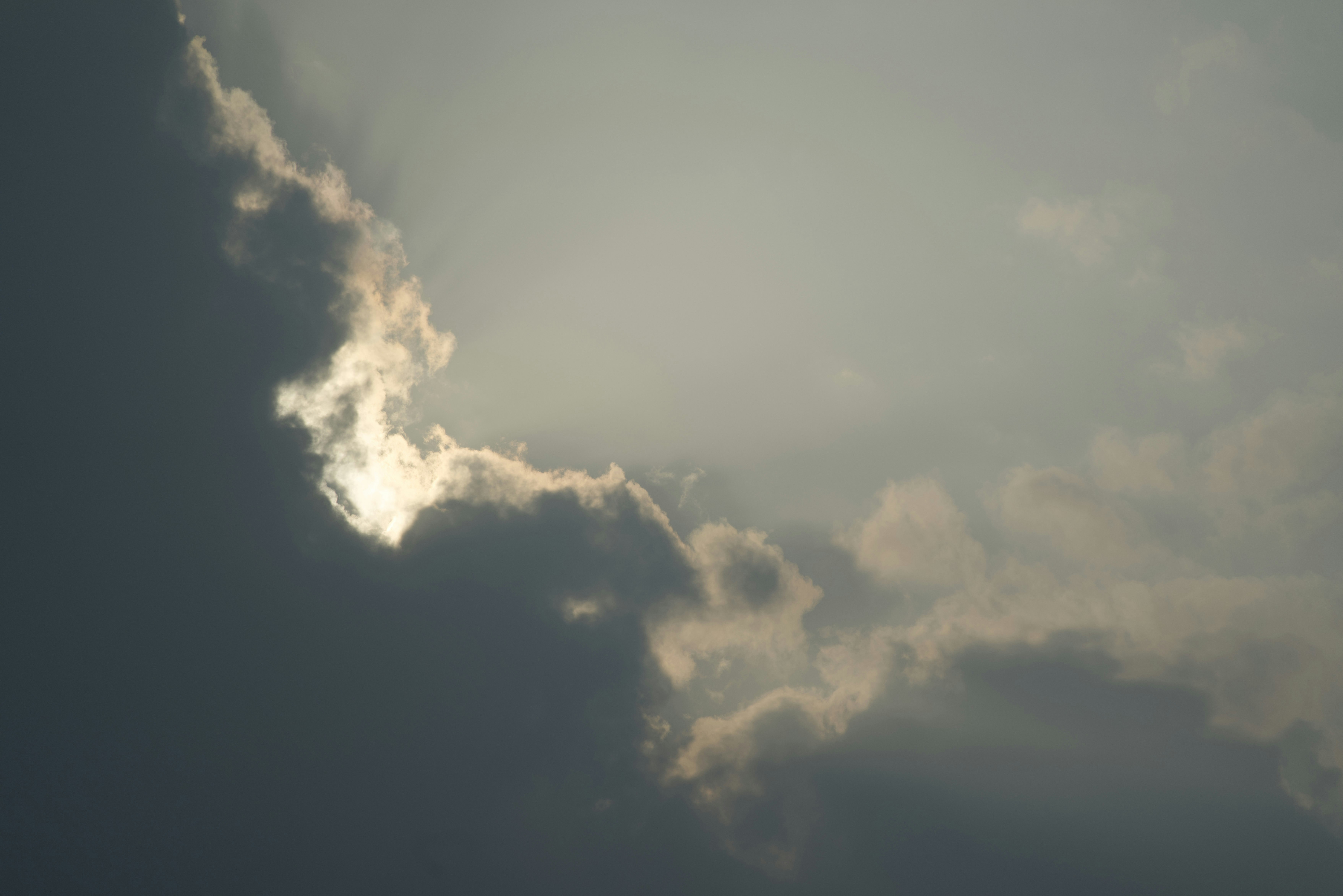Edge of Light: A Sliver of Sun Breaching Heavy Clouds