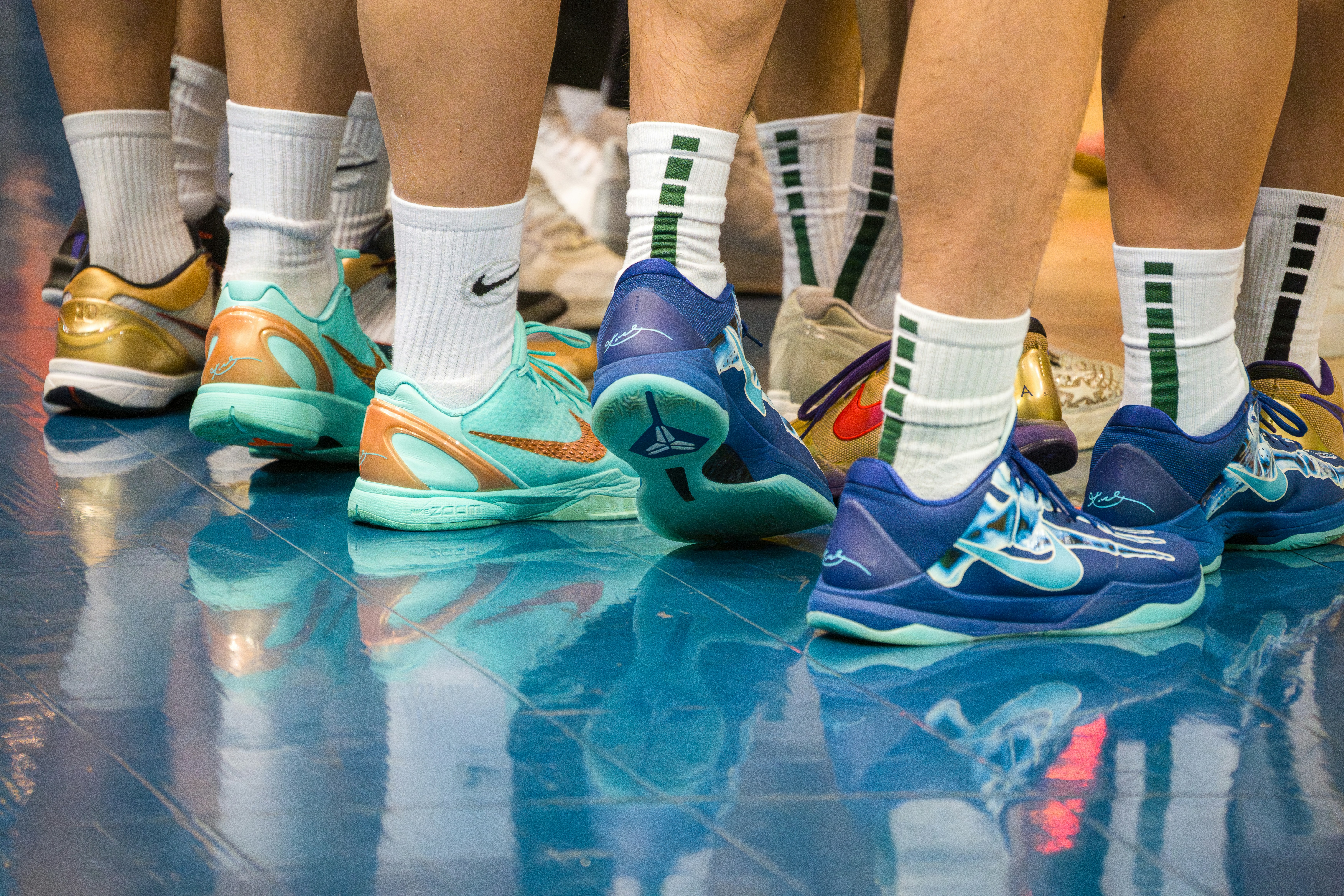 Team Huddle: Colorful Athletic Shoes on a Glossy Court