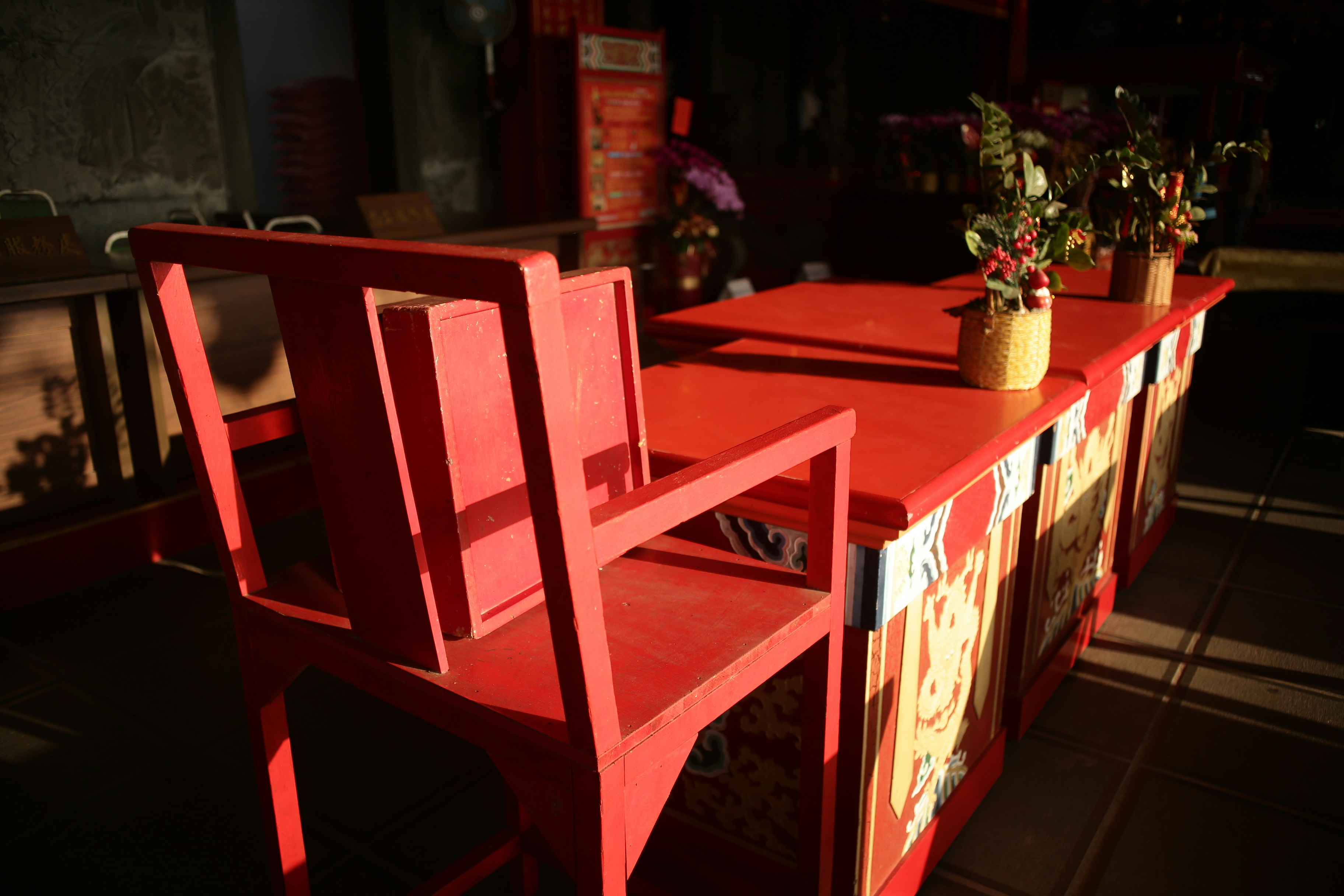 Red Studio Bar with Sunlit Counter and Floral Accent