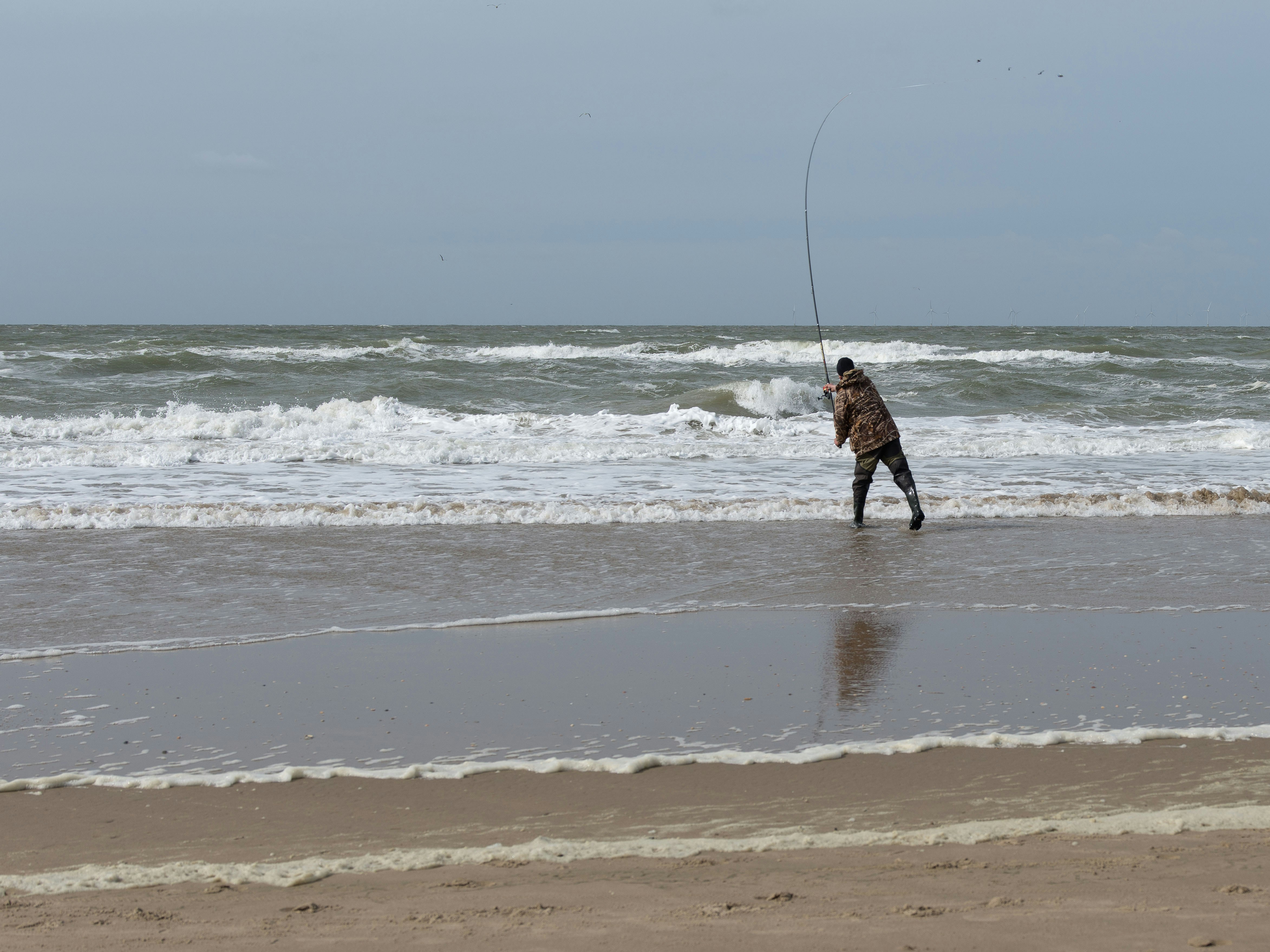 Line-Driven Tides: A Solo Angler at the Edge of a Dim Horizon