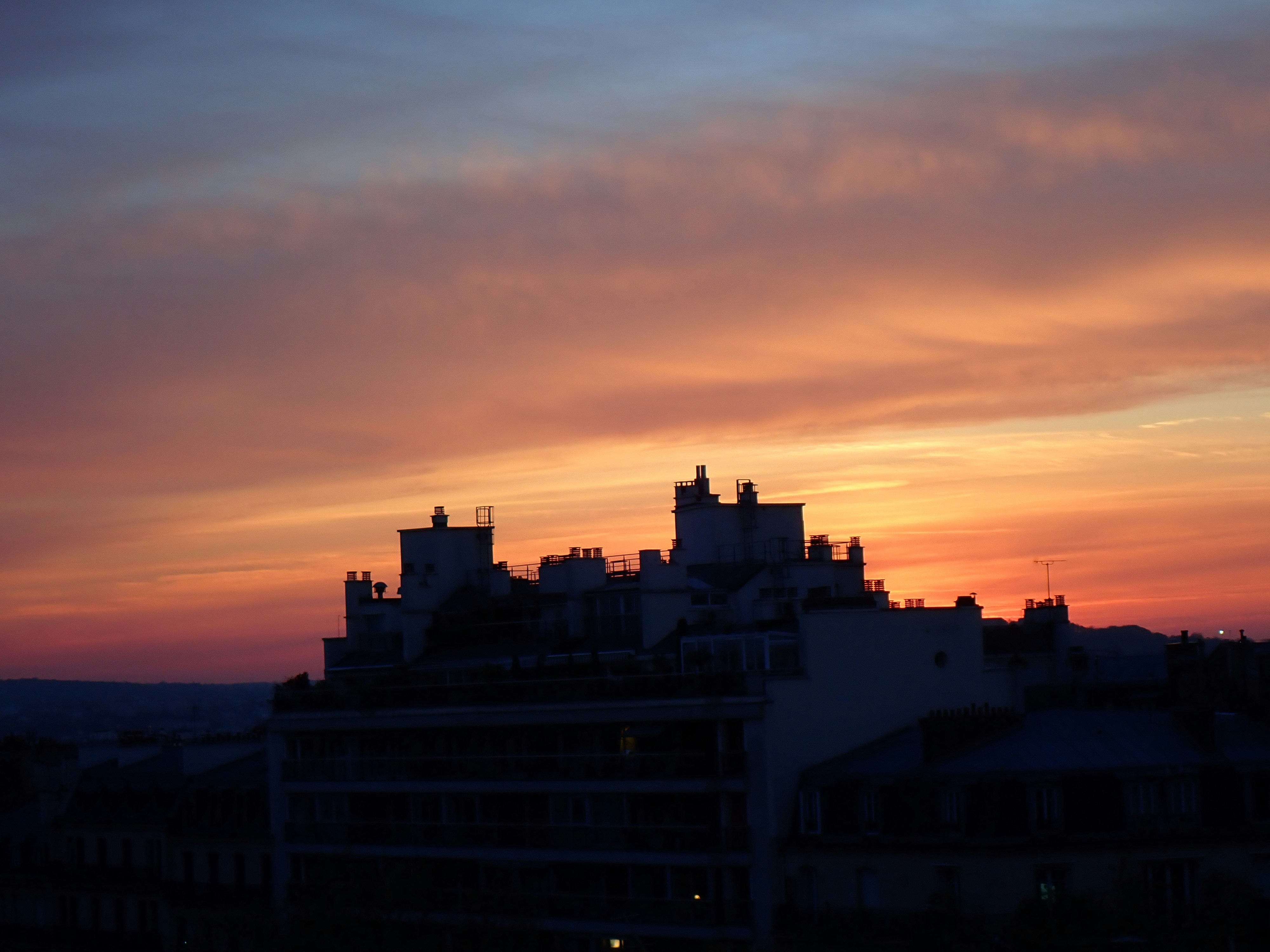 Sunset Overward: Rooftop silhouettes at dusk