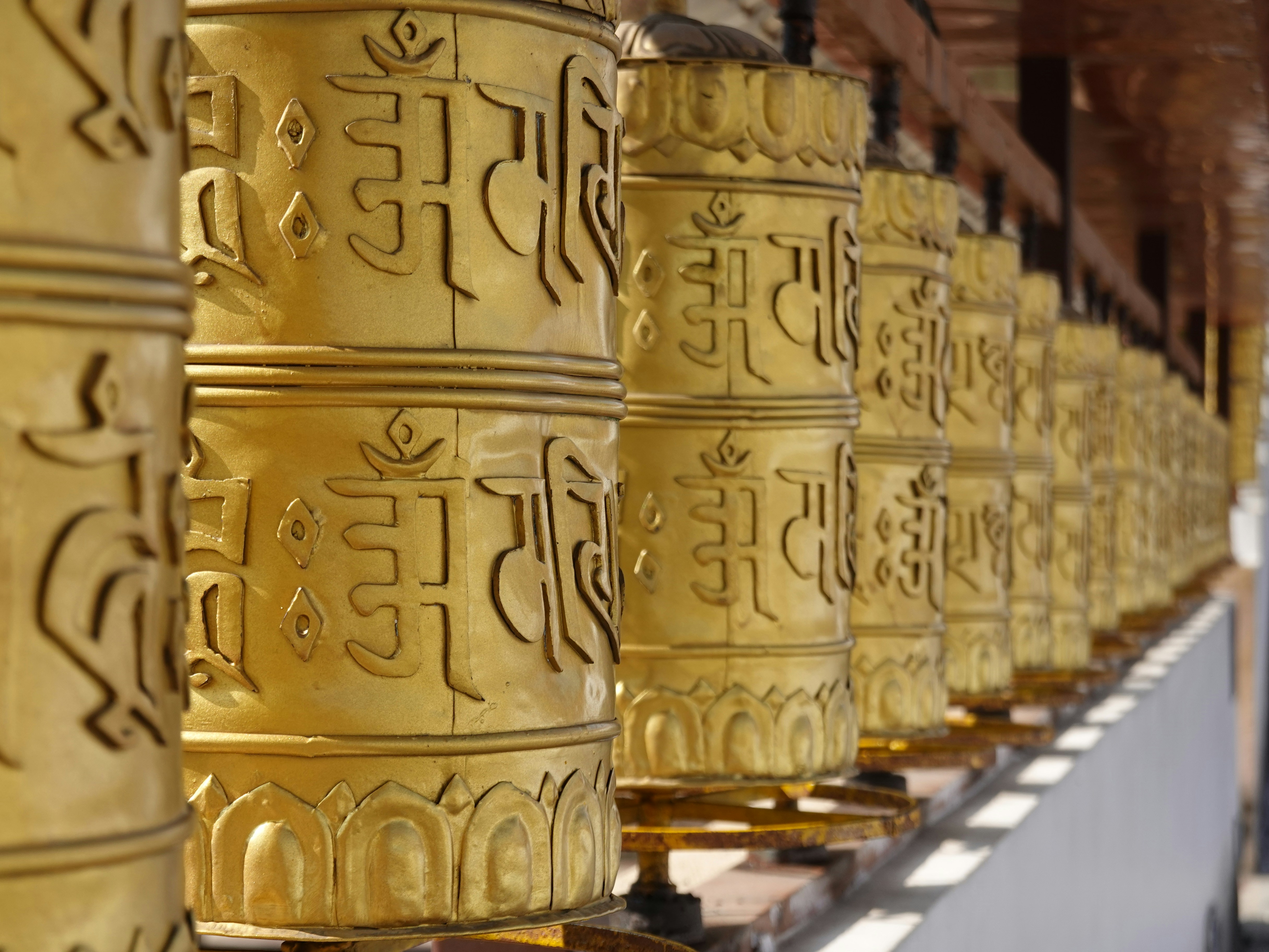 Row of Golden Prayer Wheels: Reverence in Motion