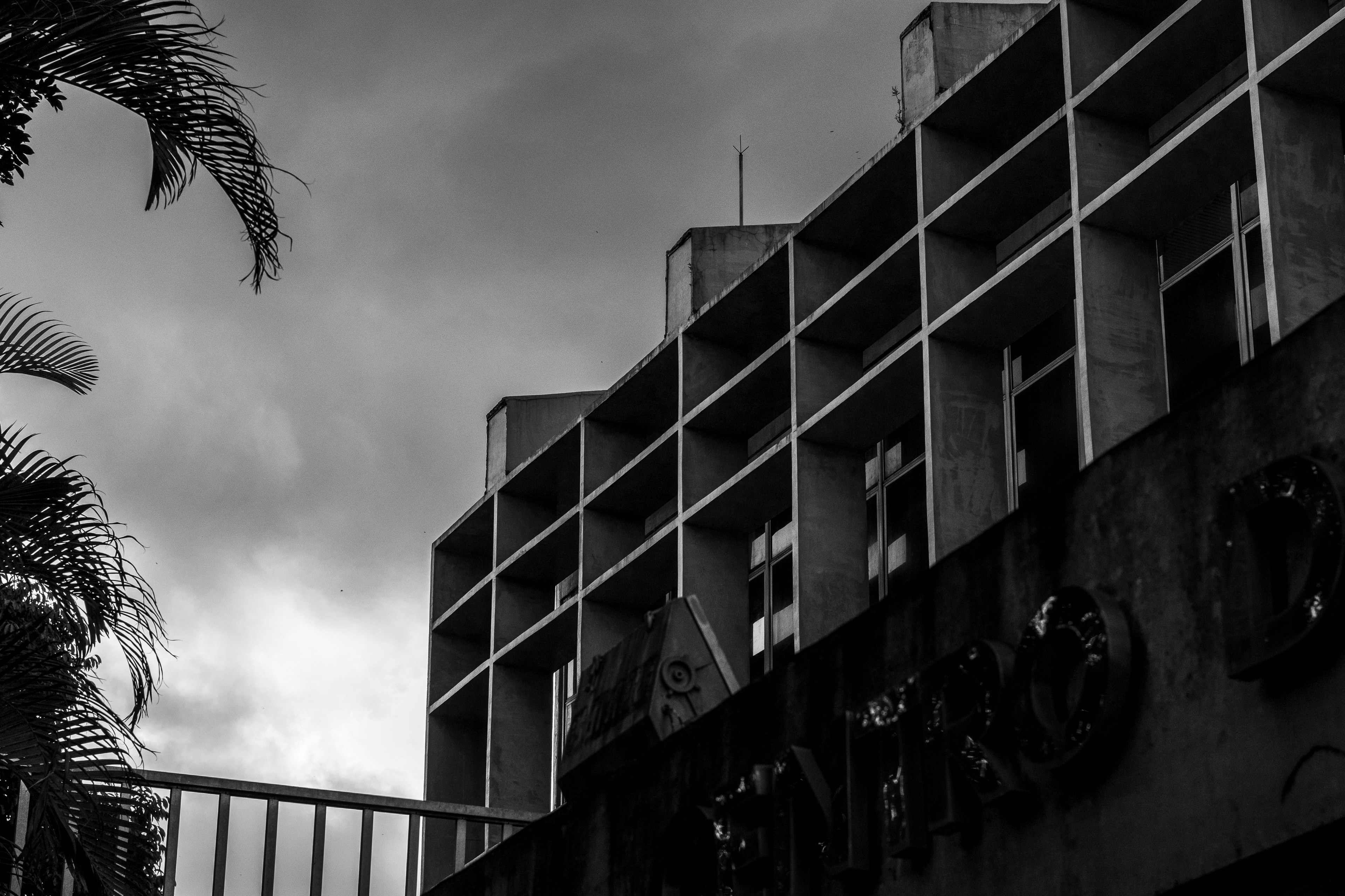 Concrete Grid and Shadowed Facade under a Looming Sky