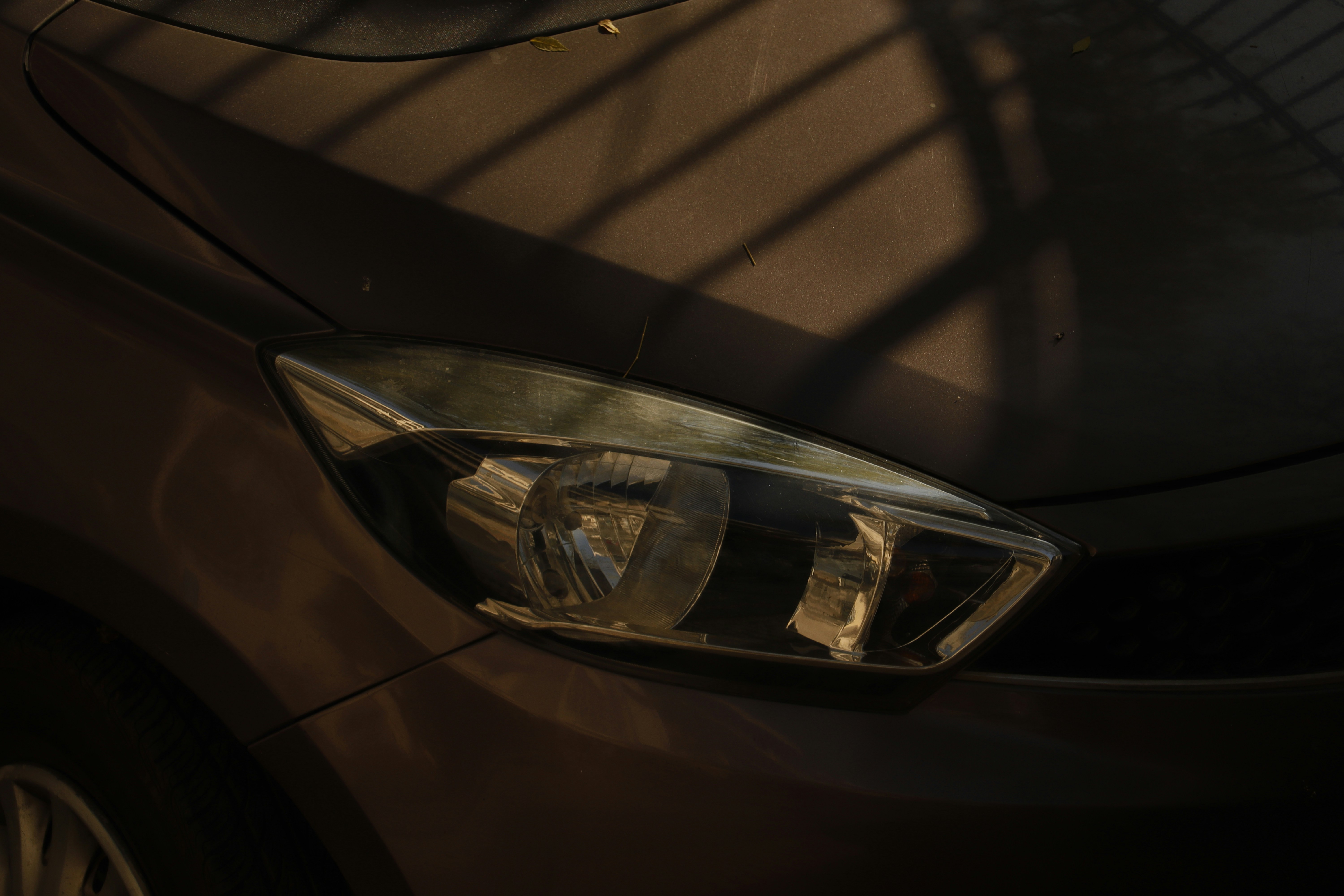 Midnight Car Facade: A Stubbed Headlight under Shaded Stripes