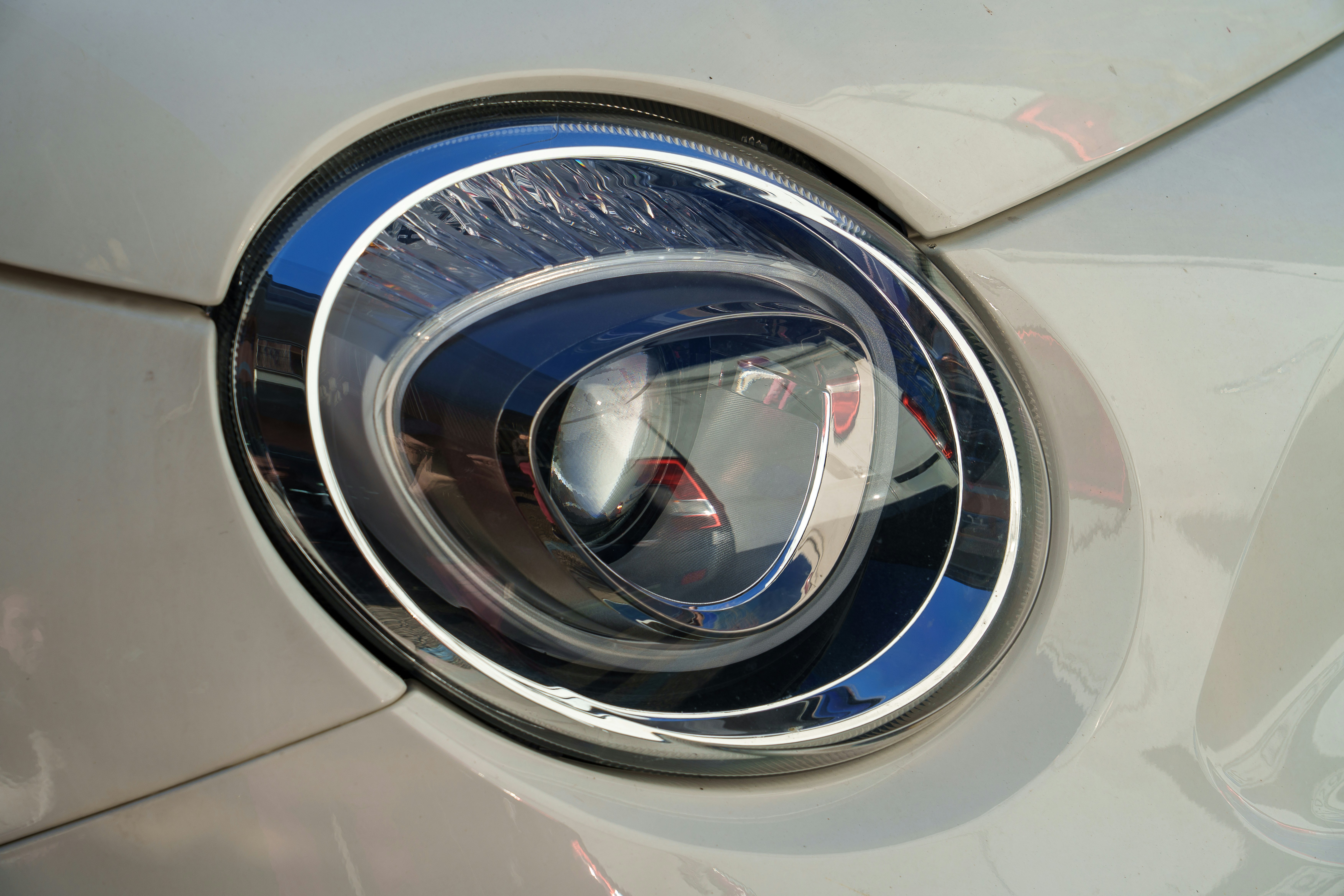 Close-up of a Modern Car Headlight: Circular LED Ring with Reflective Chrome