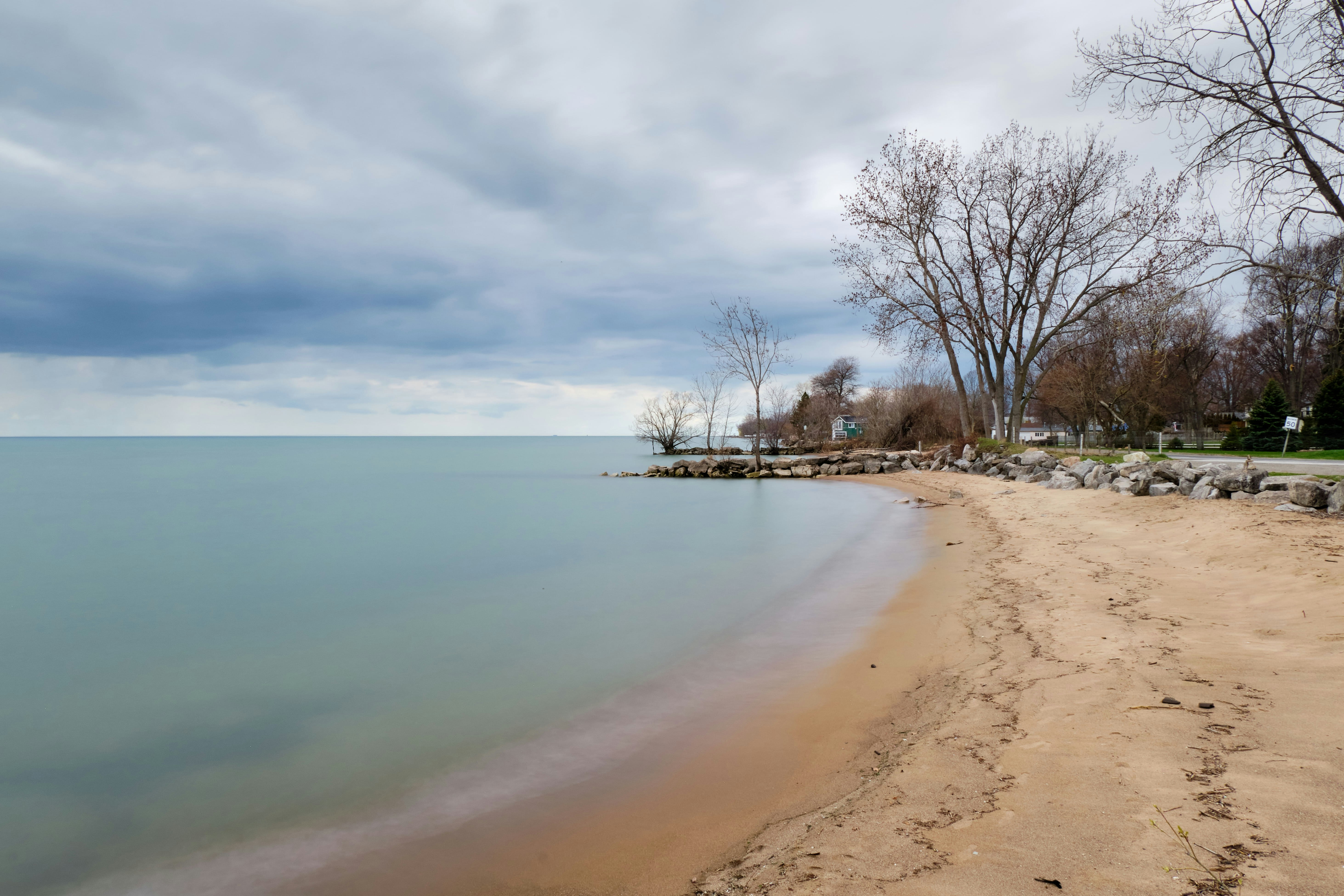 Calm shoreline under a brooding sky
