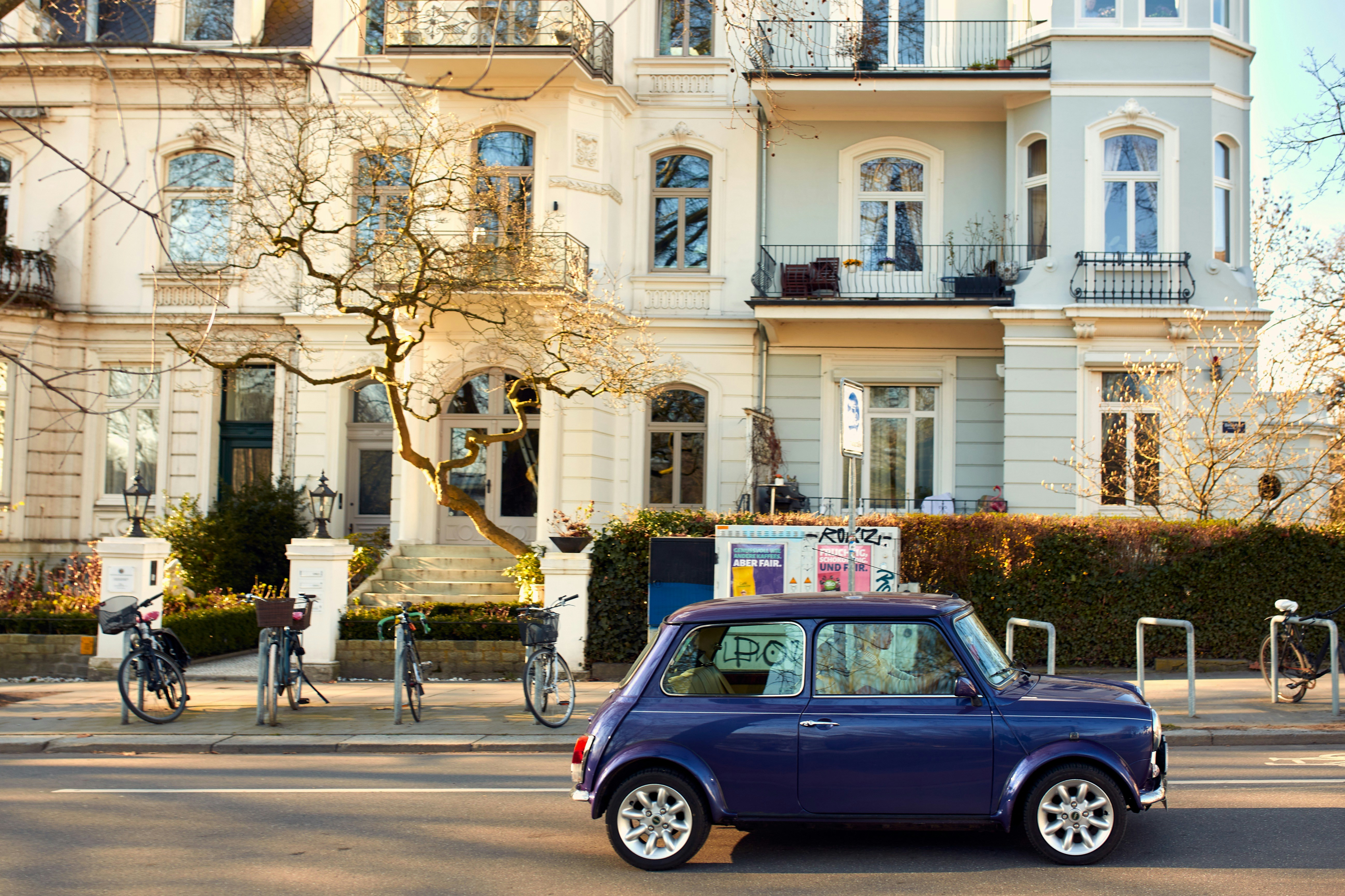 Blue vintage car as centerpiece on a sunlit European street