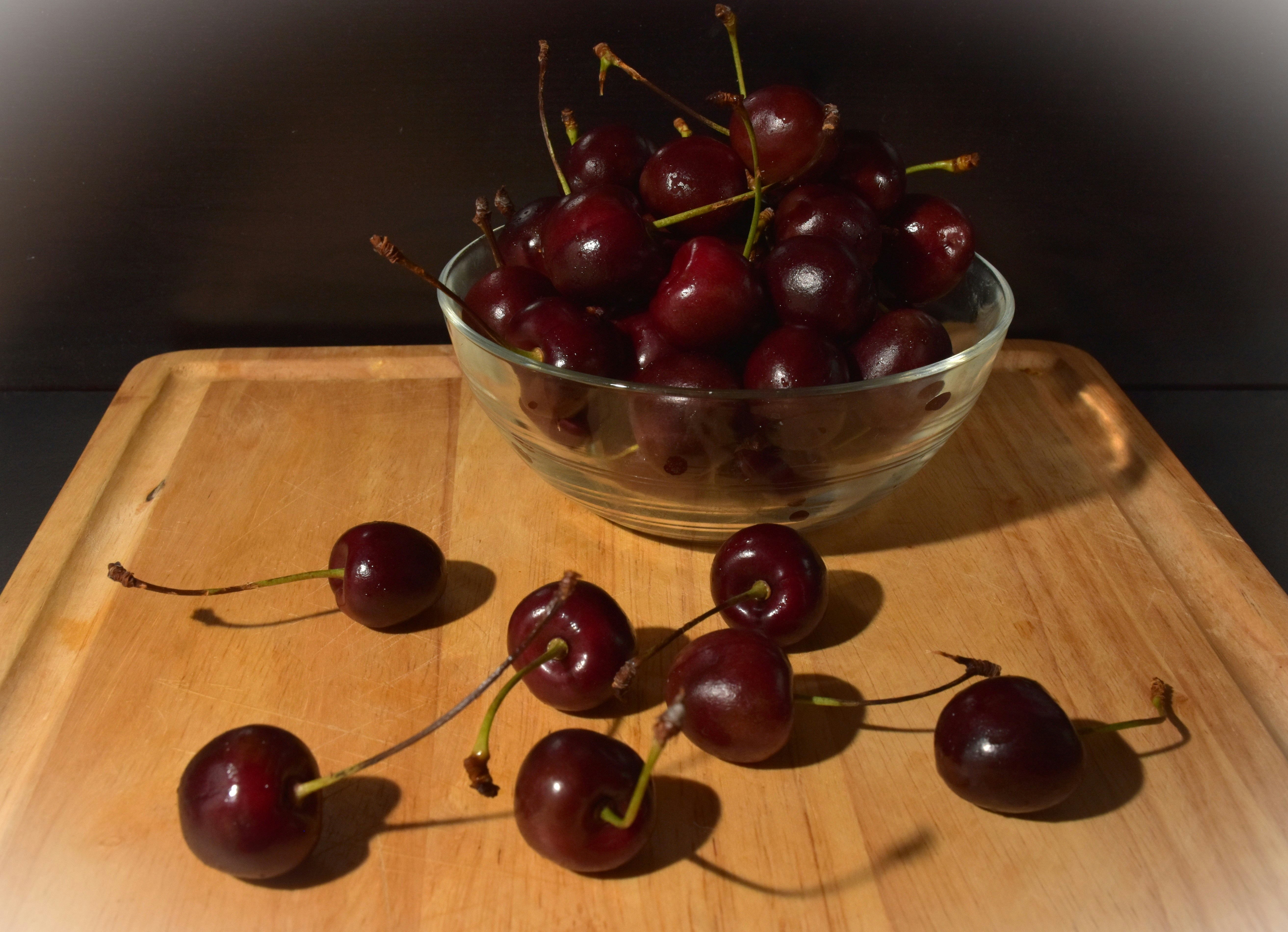 Cherry Still Life: A Bowl of Dark Berries on a Wooden Tray
