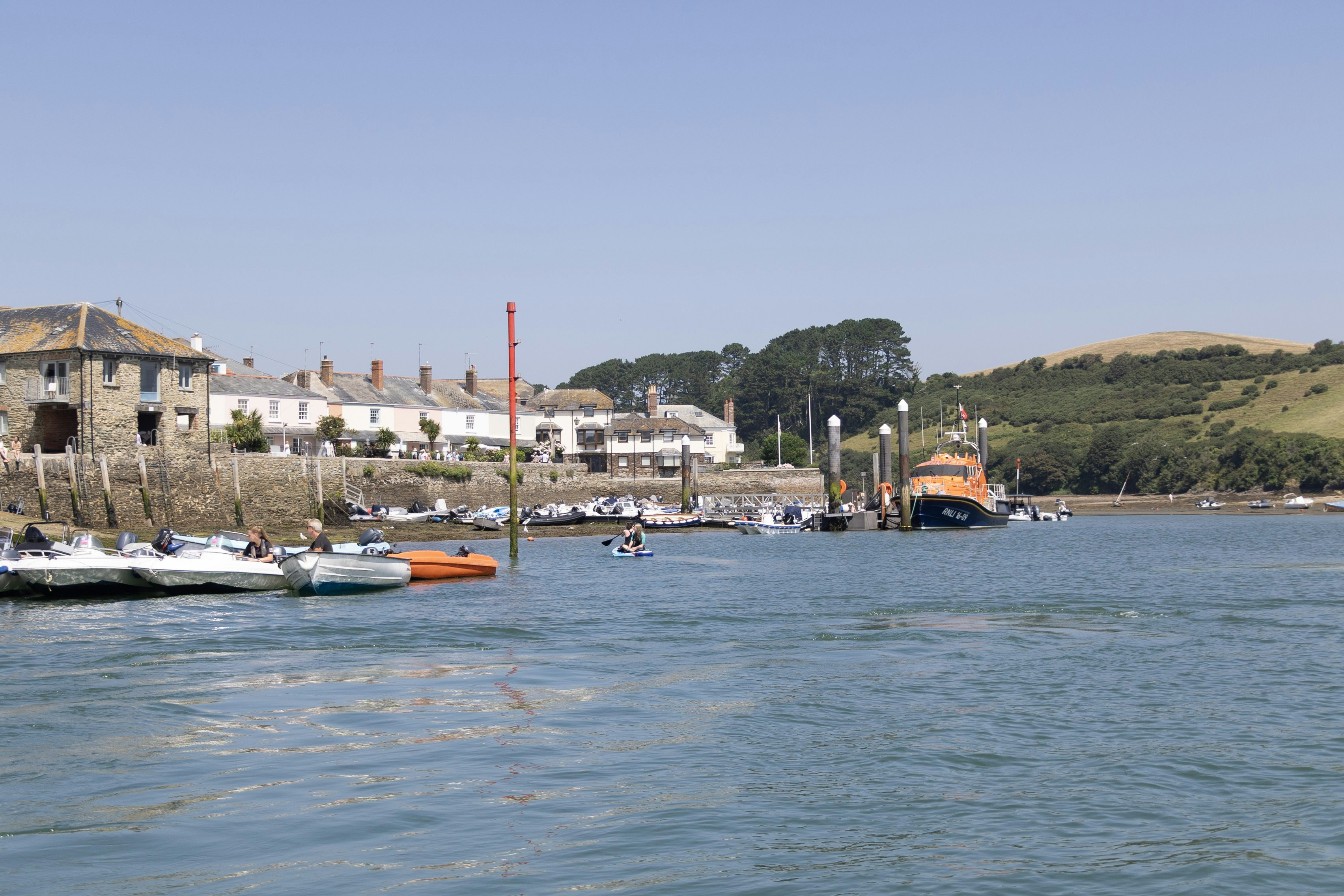 Quiet Harbor Aftermath: Boats Rest Along a Coastal Village