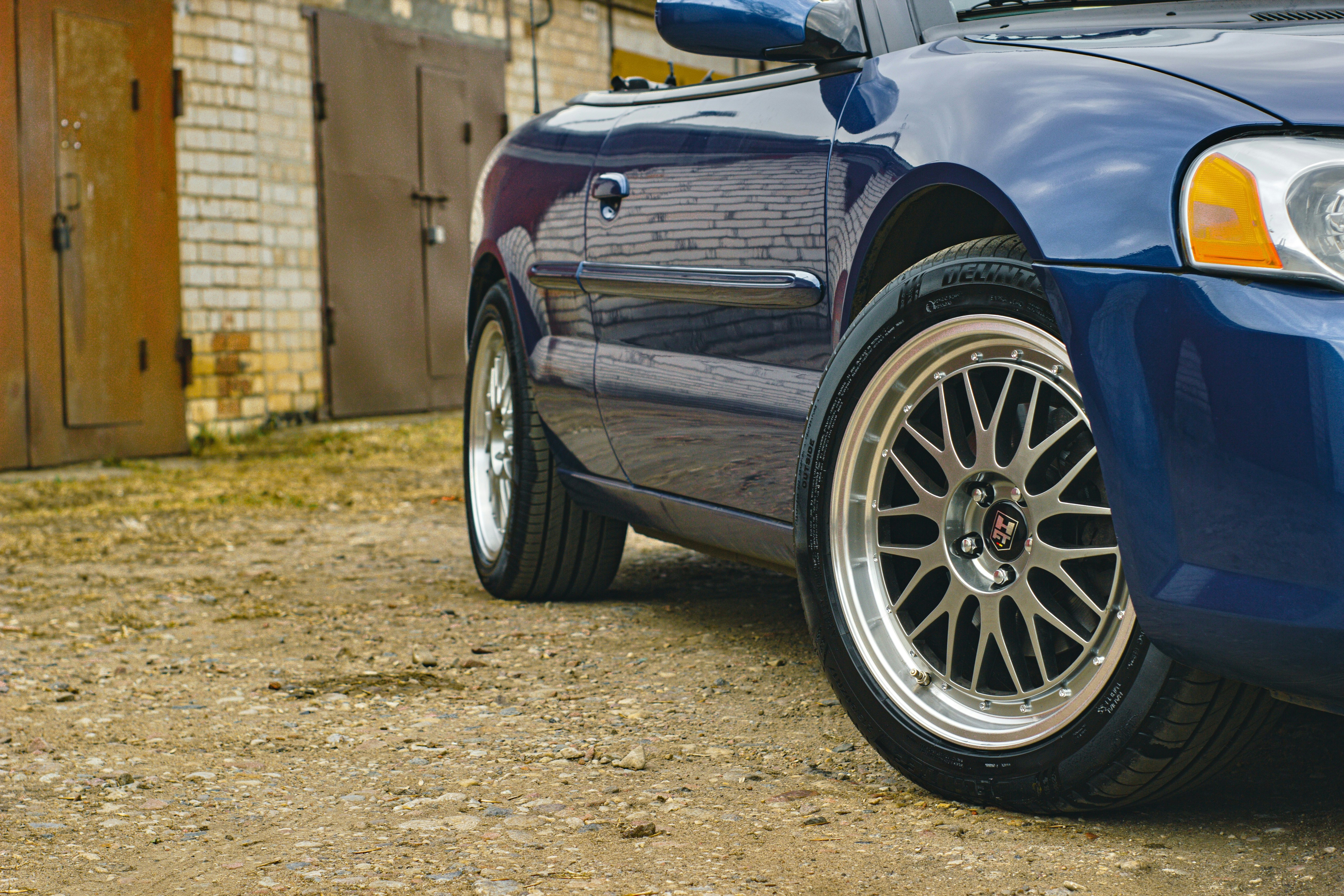 Blue Slope: Close-Up of a Classic Car Wheel and Body Curves
