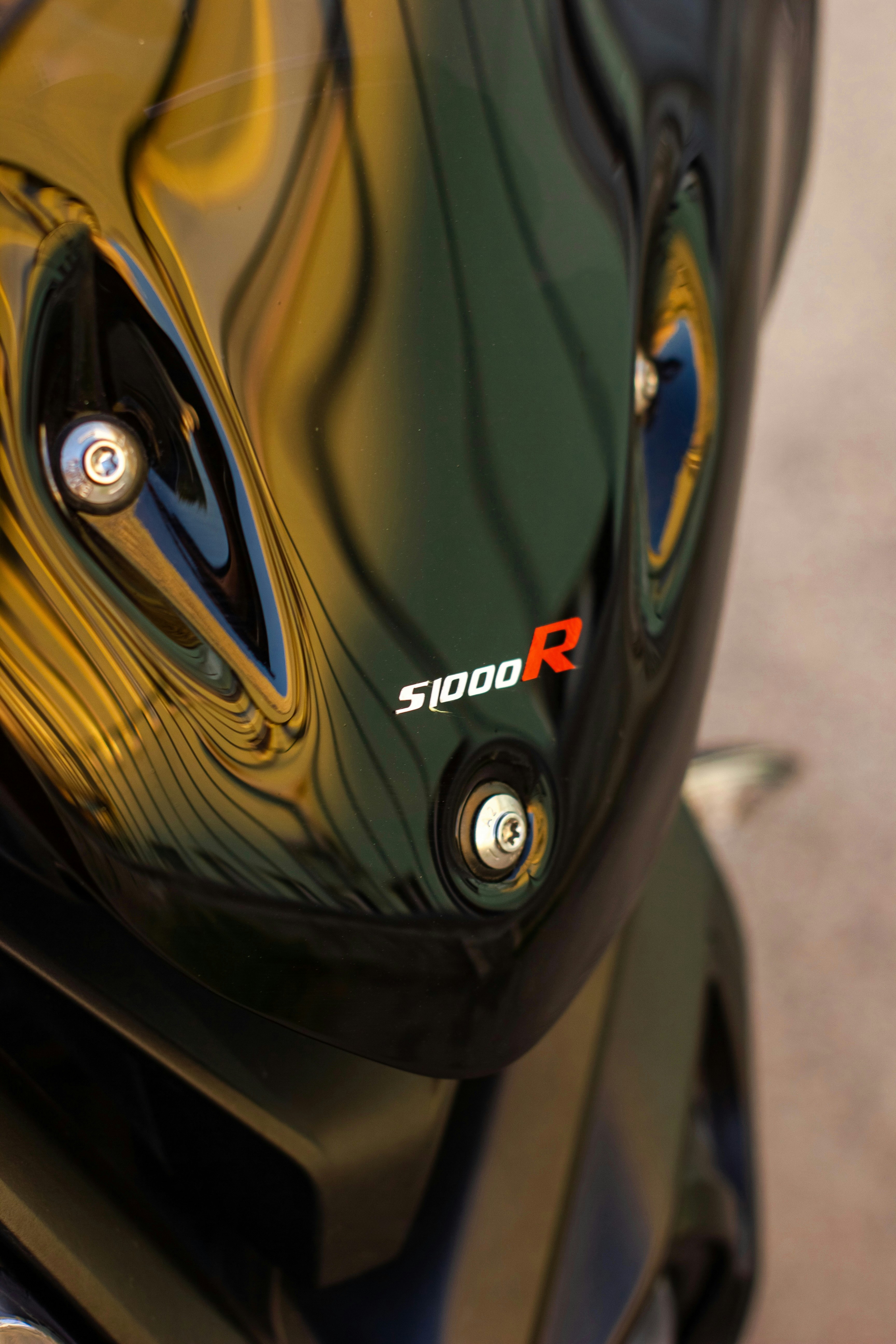 Chromatic Reflection on a Sleek Moto: S1000R Badge in Focus