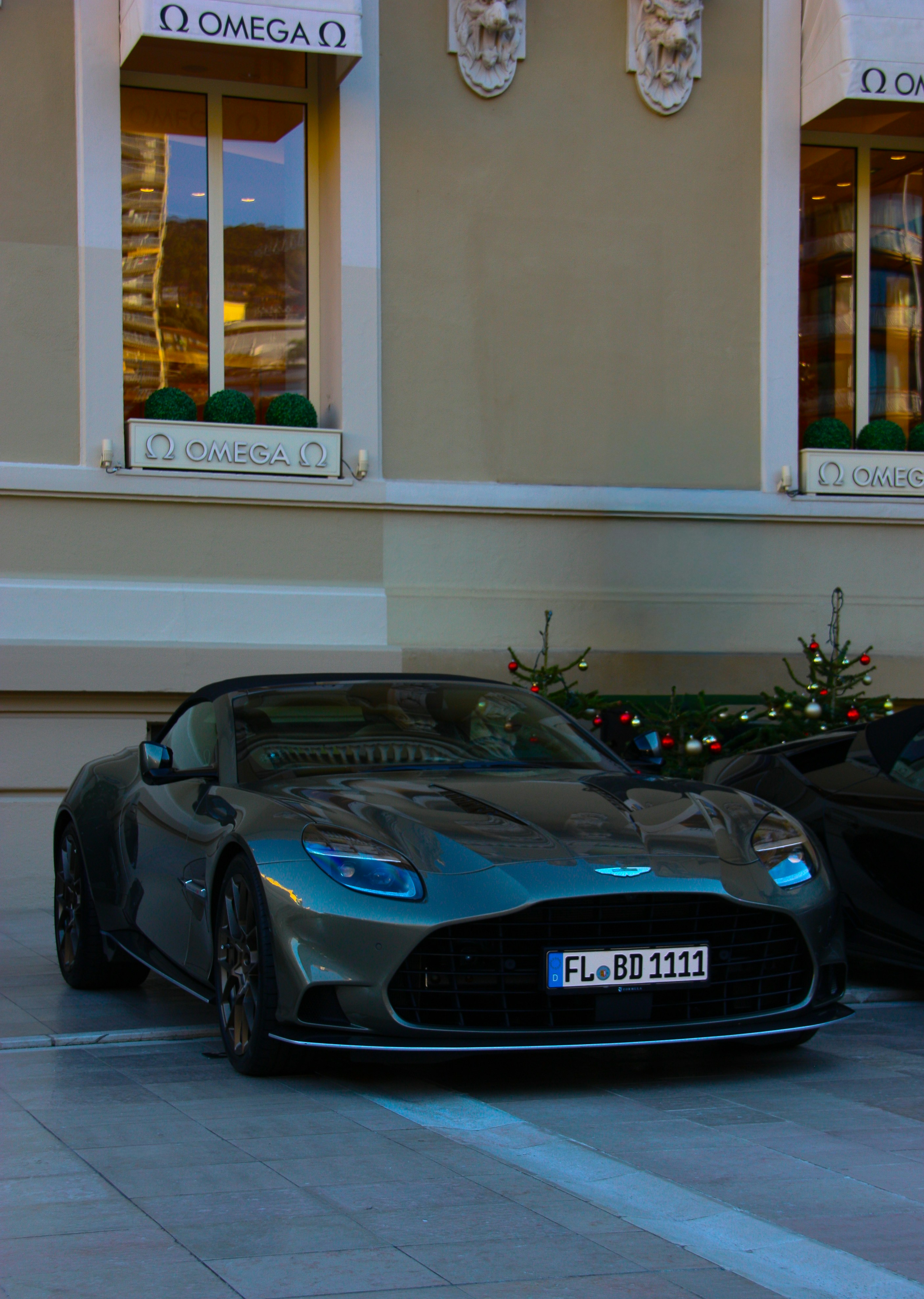 Grey Aston Martin Dream: a parked luxury in a sunlit courtyard