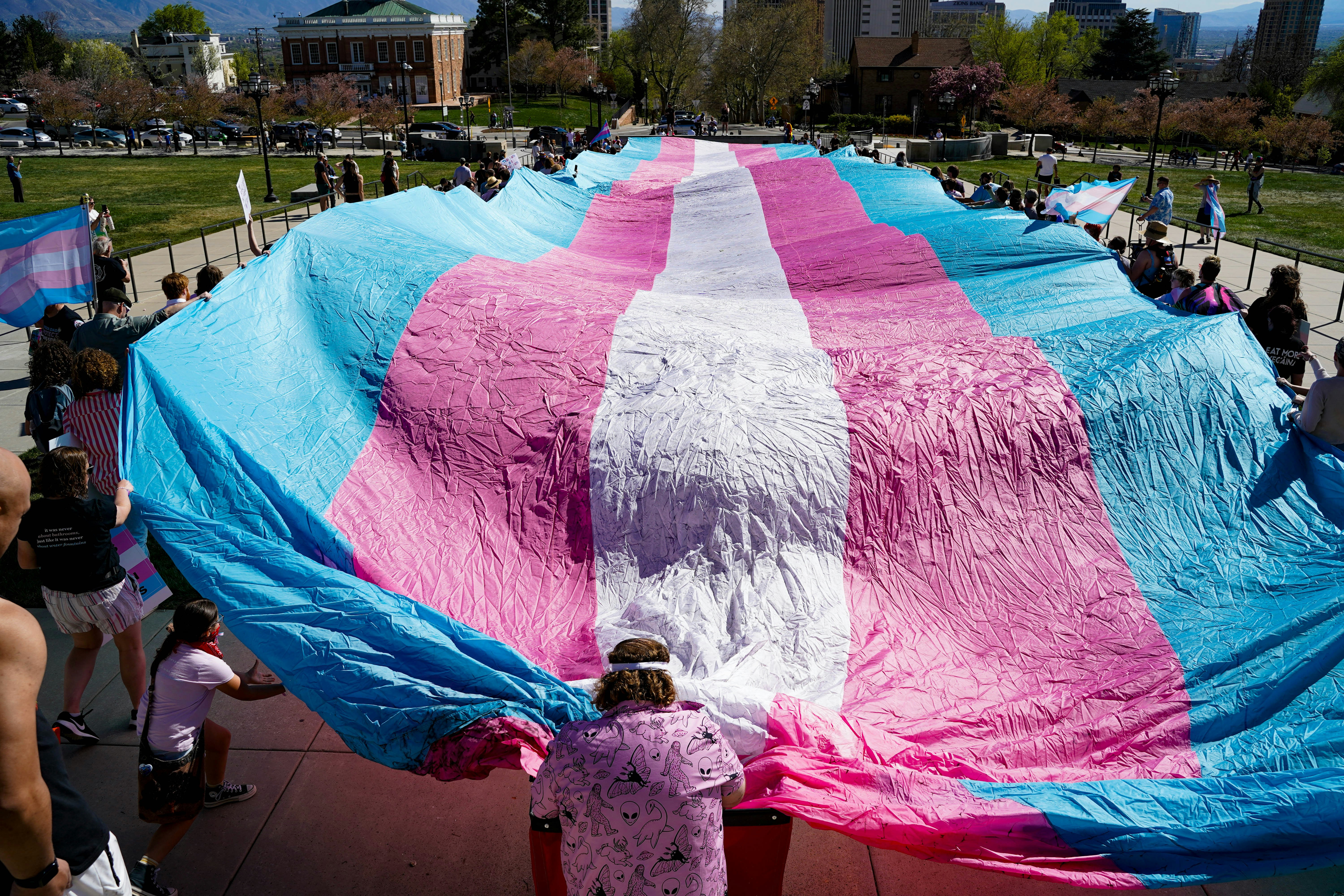 Community Parade Draped in a Giant Pride Flag
