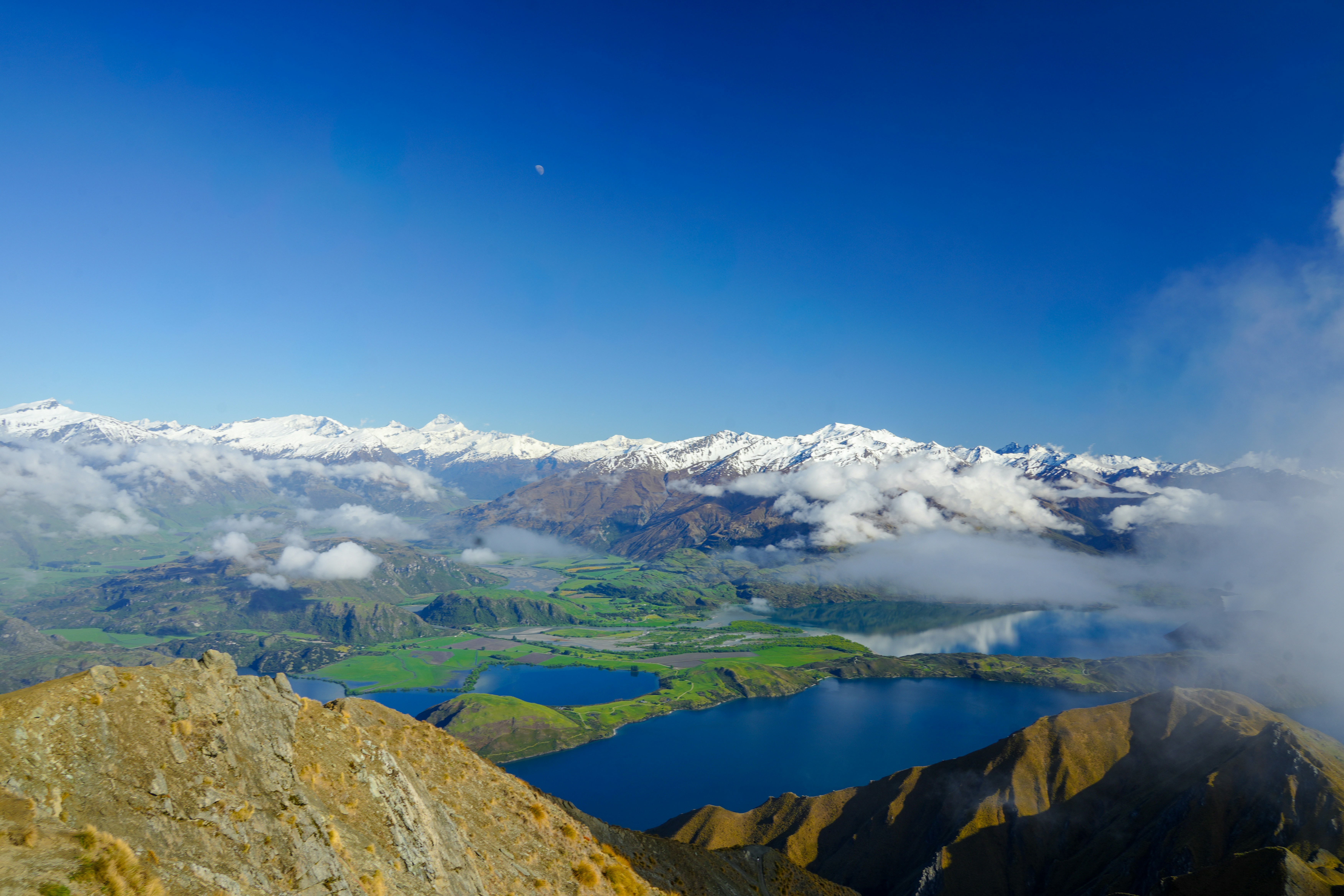 Apex of Serenity: Snow-Capped Ridge Over Electric Valleys