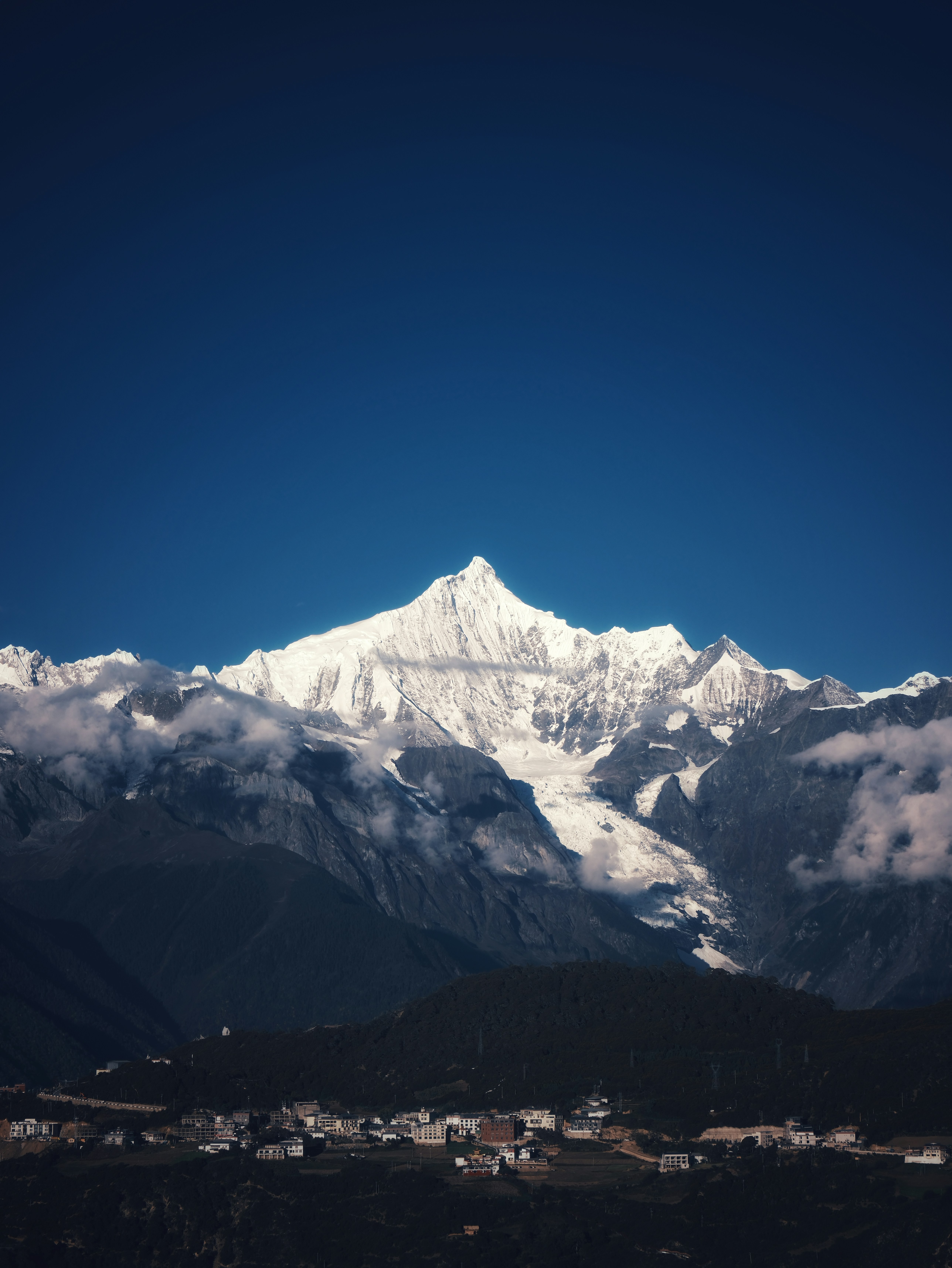 Snow Crown over the Valley: A Mountain Village Under Blue Silence