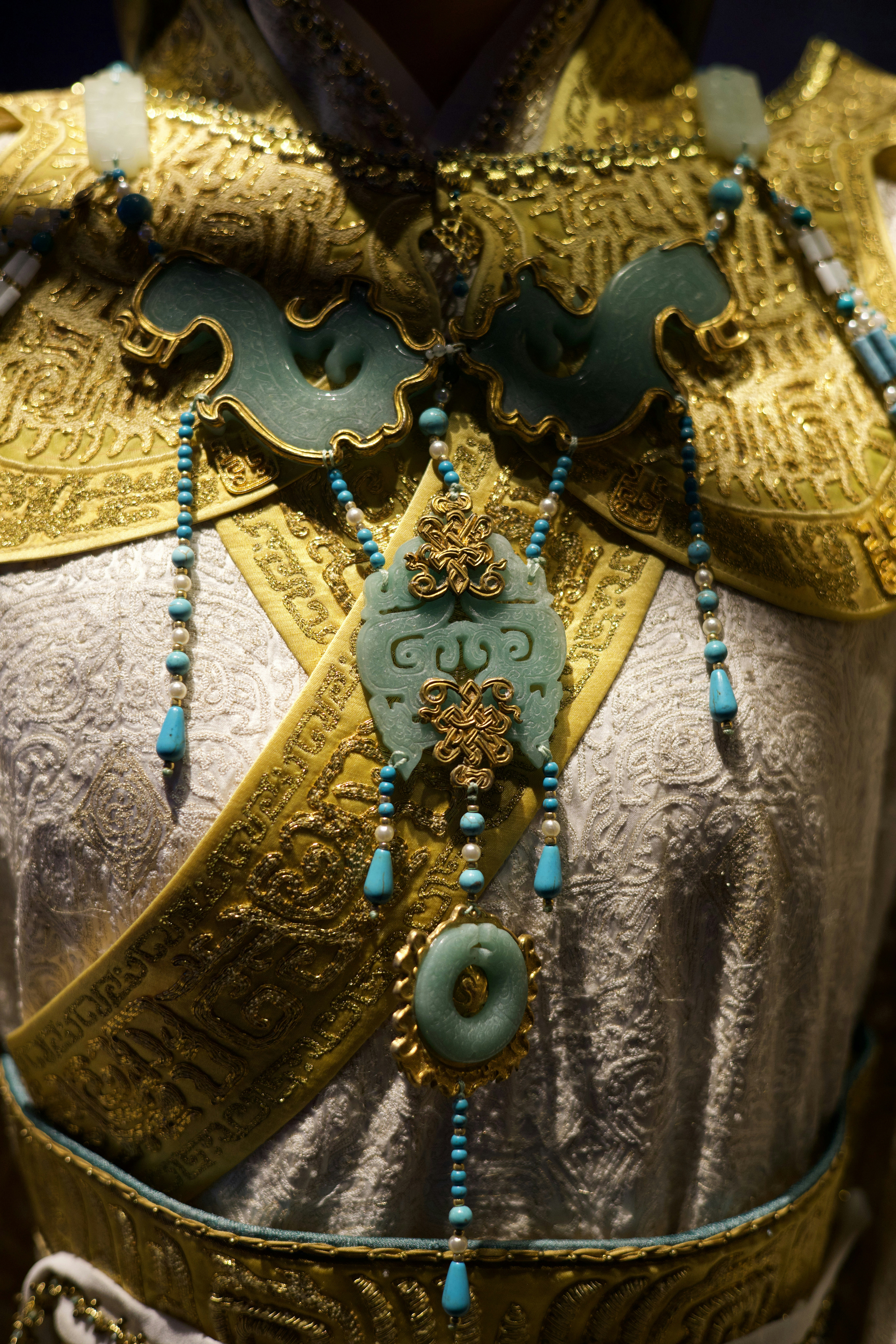 Teal Medallions Adorning Regal Gold and Silver Attire