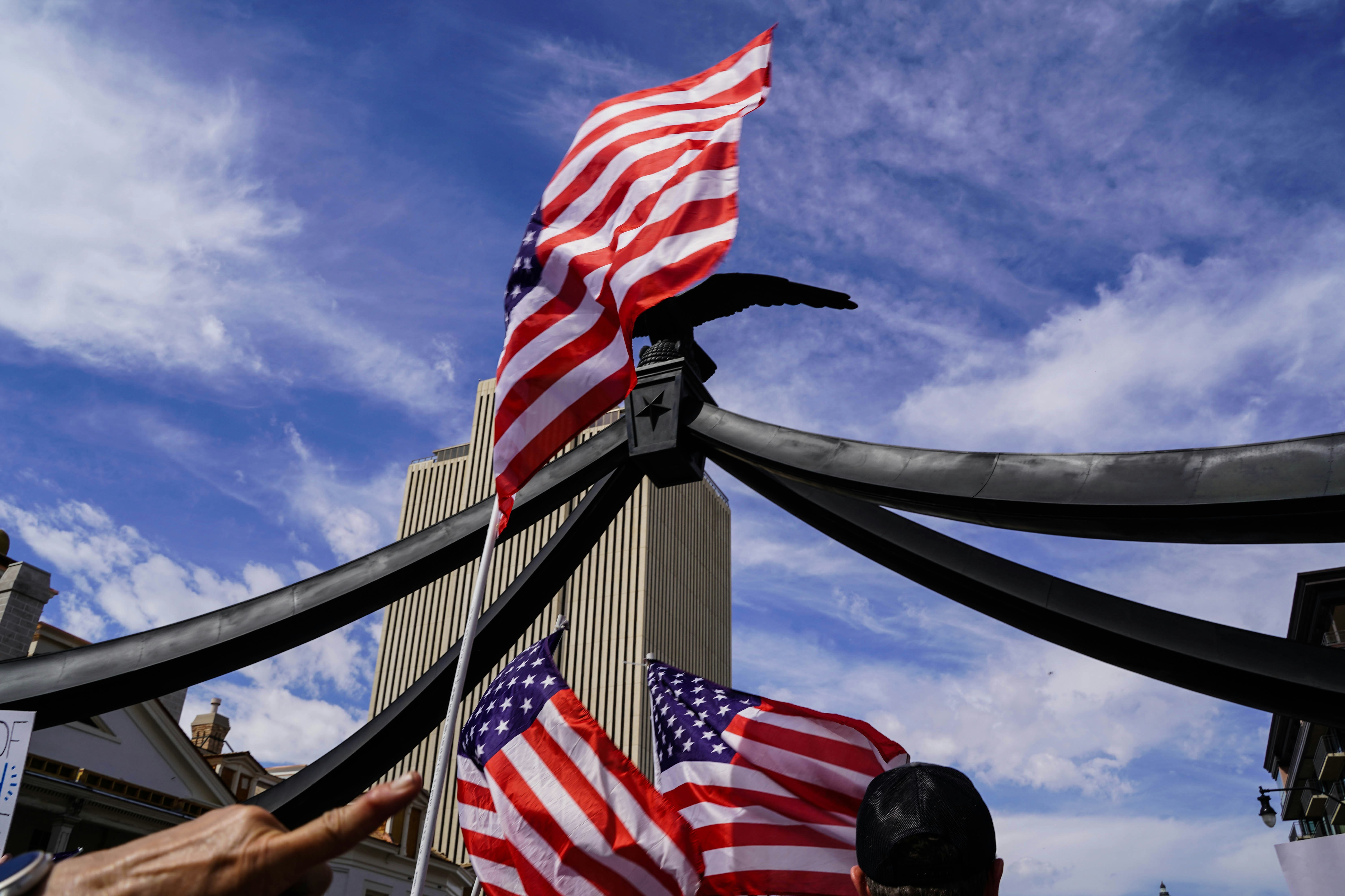 Flags in Flight Over a Cityscape Arch