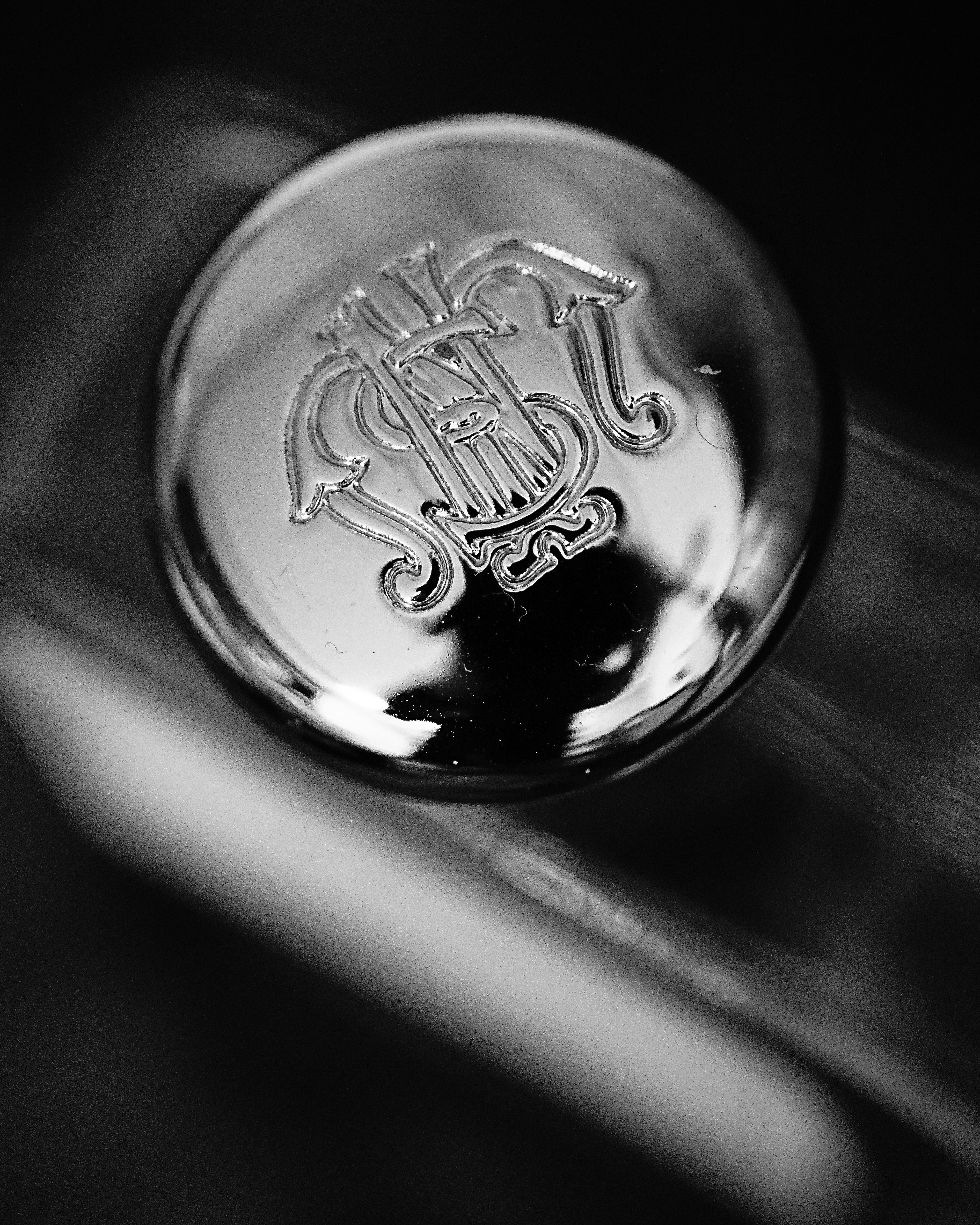 Monogramed Gear: The Shaped Emblem on a Gleaming Screw Caps
